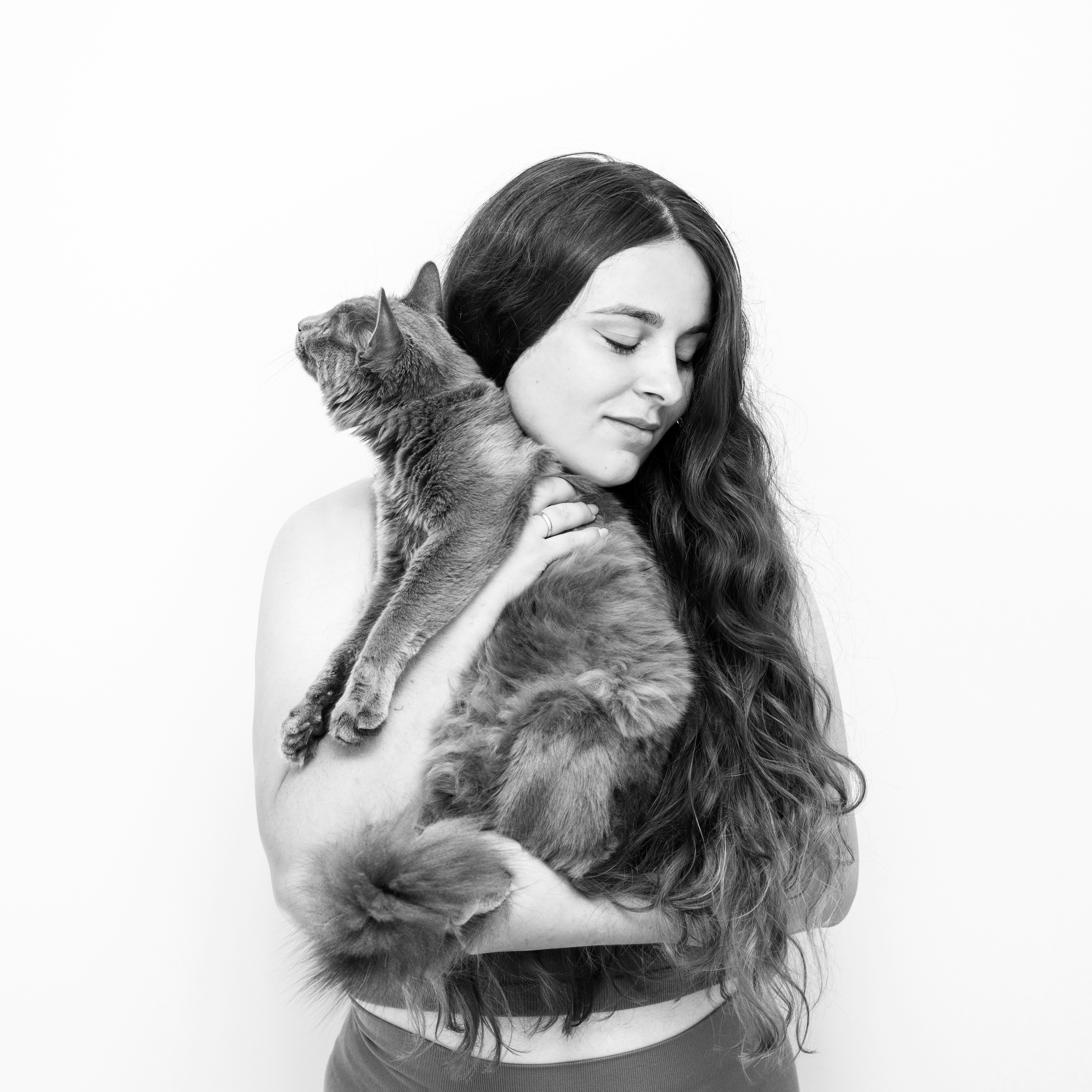 Gentle Embrace: A Woman and Her Cat in Quiet Light