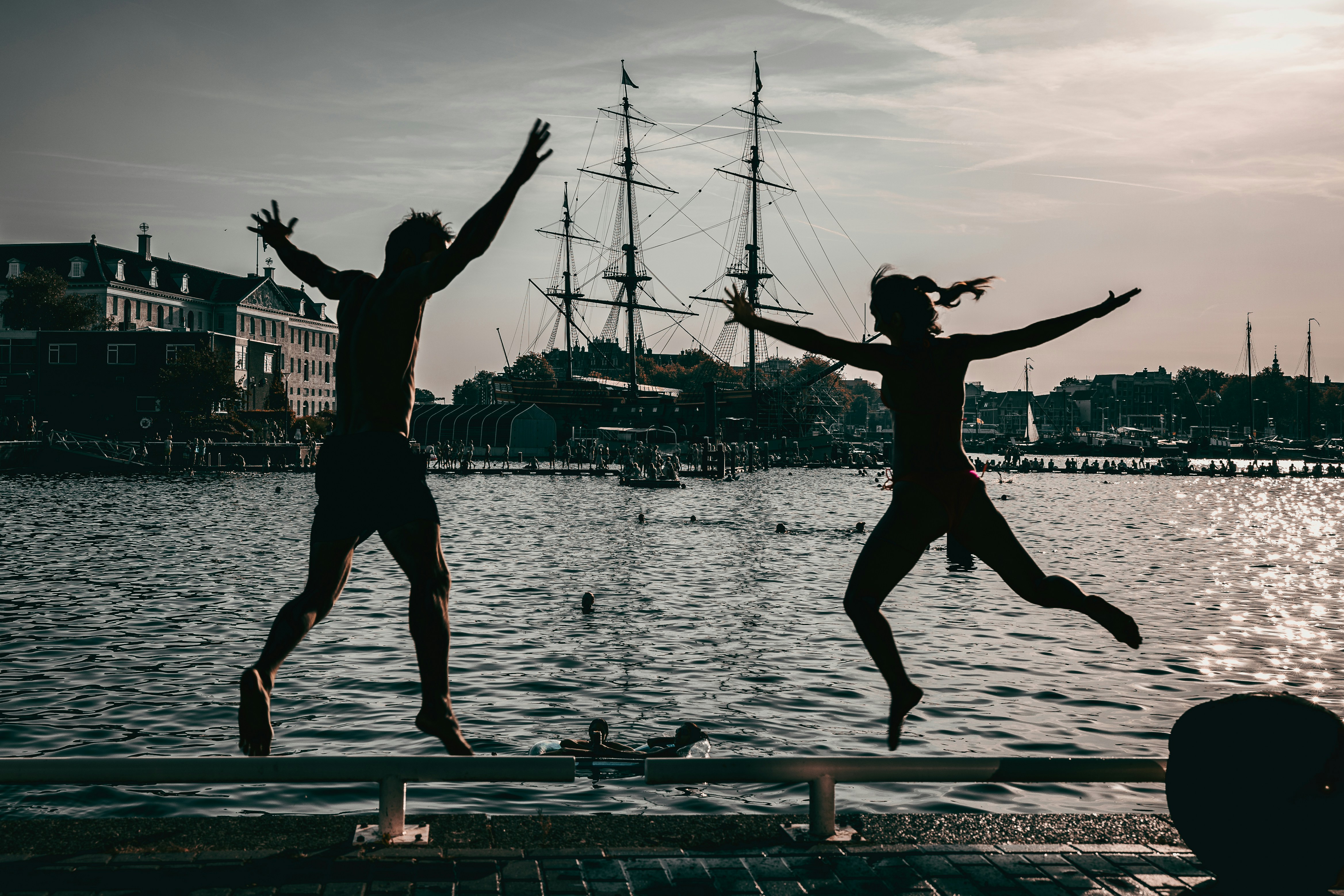 Dusk Jumpers by the Harbor: Silhouettes Against the Sail-Clad Horizon
