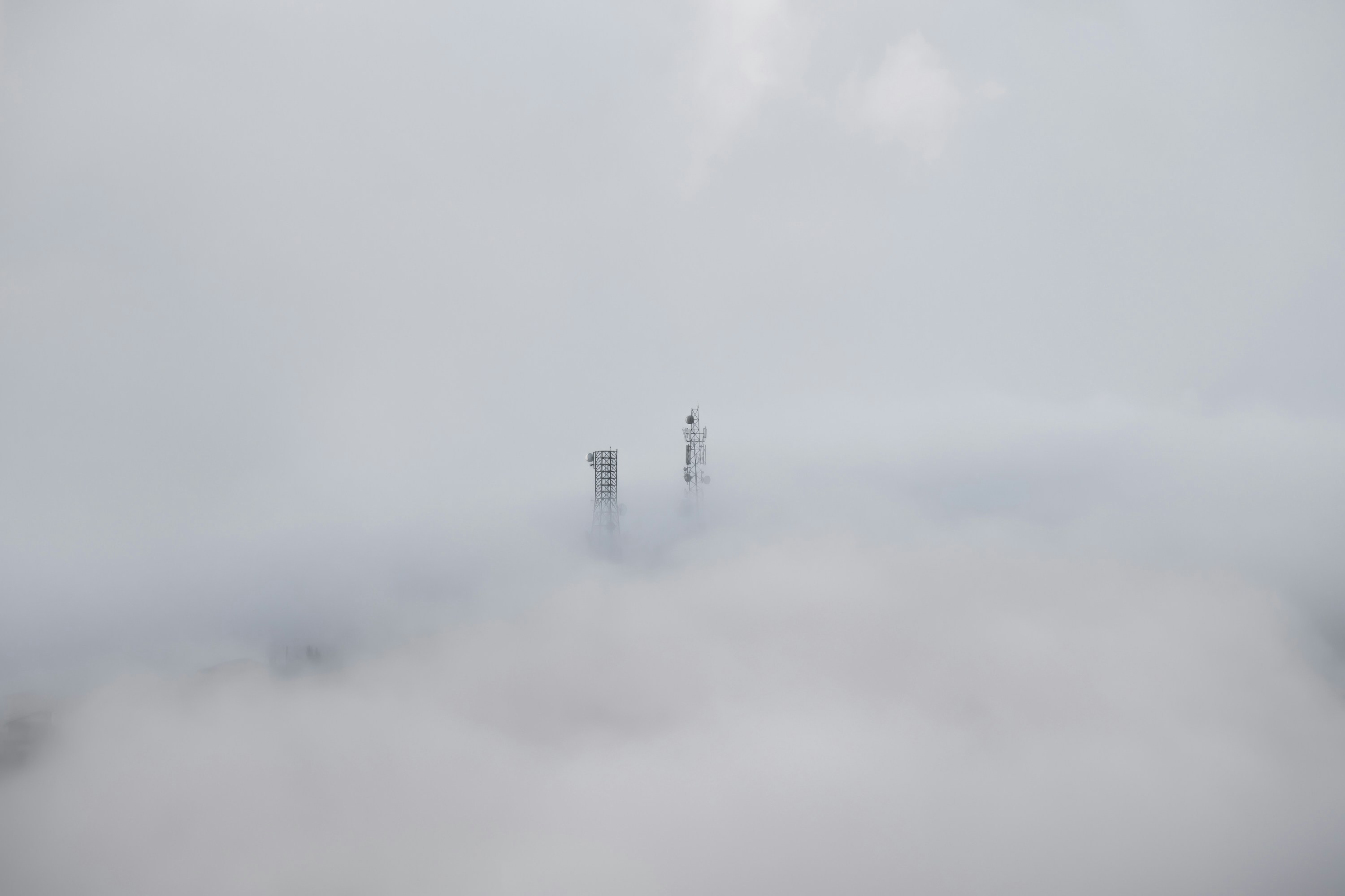 Twin Masts Breaching the Cloud Veil