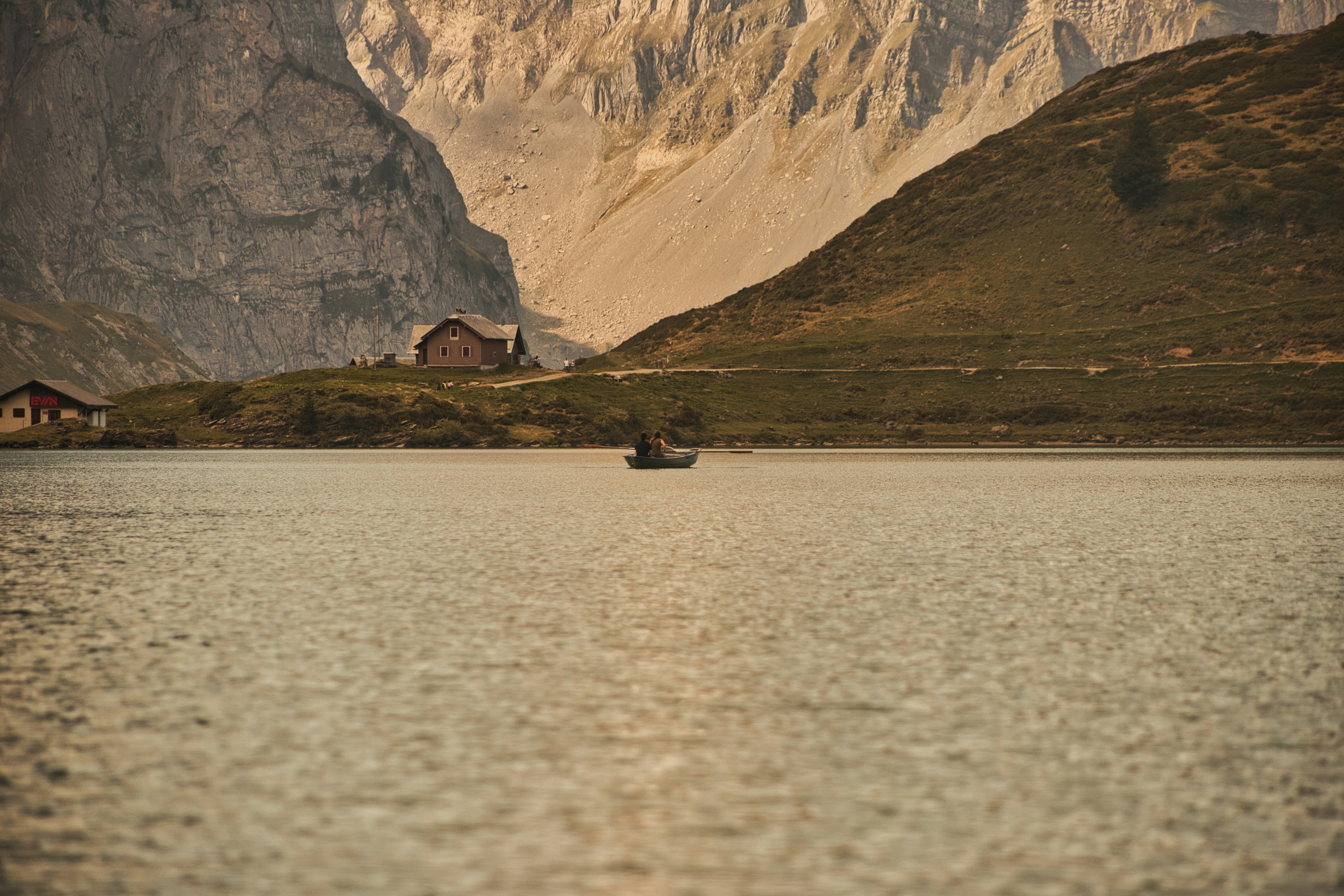 Alpine Lake Quietude: A Lone Boat Against Rugged Peaks