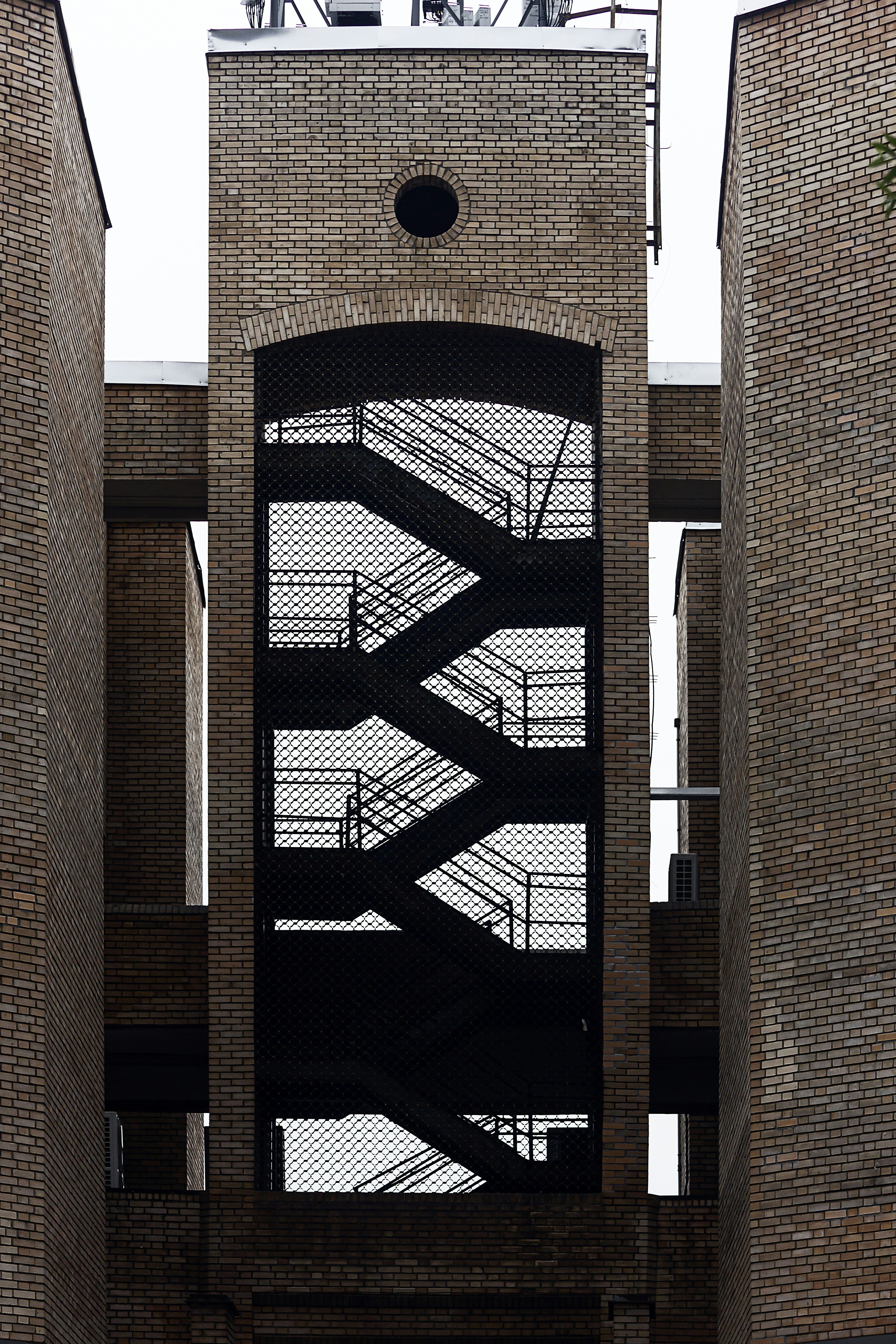 Interlocked Staircase: A Symmetrical Slice of Brick and Light