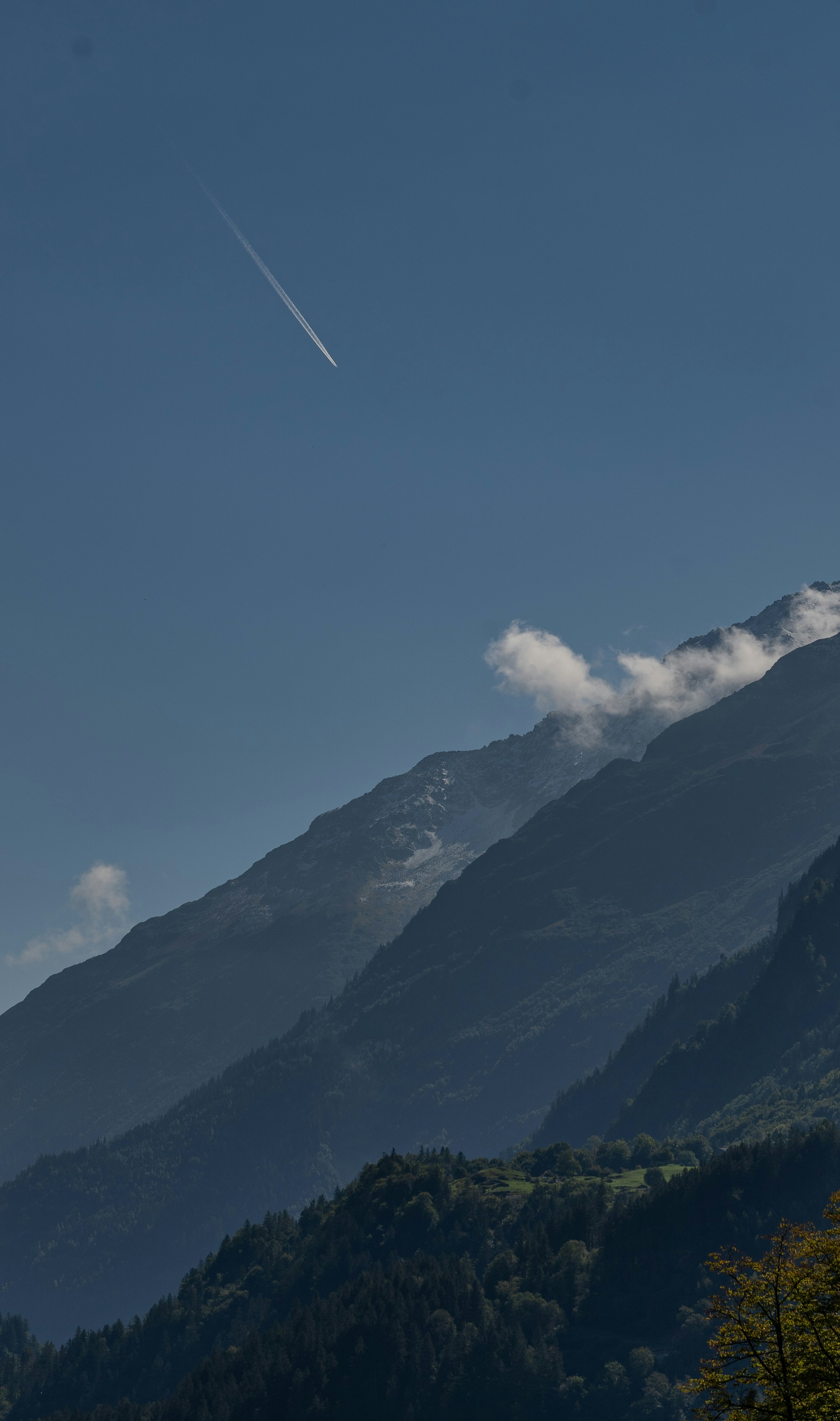 Jet Trail Above the Mountain Ridge