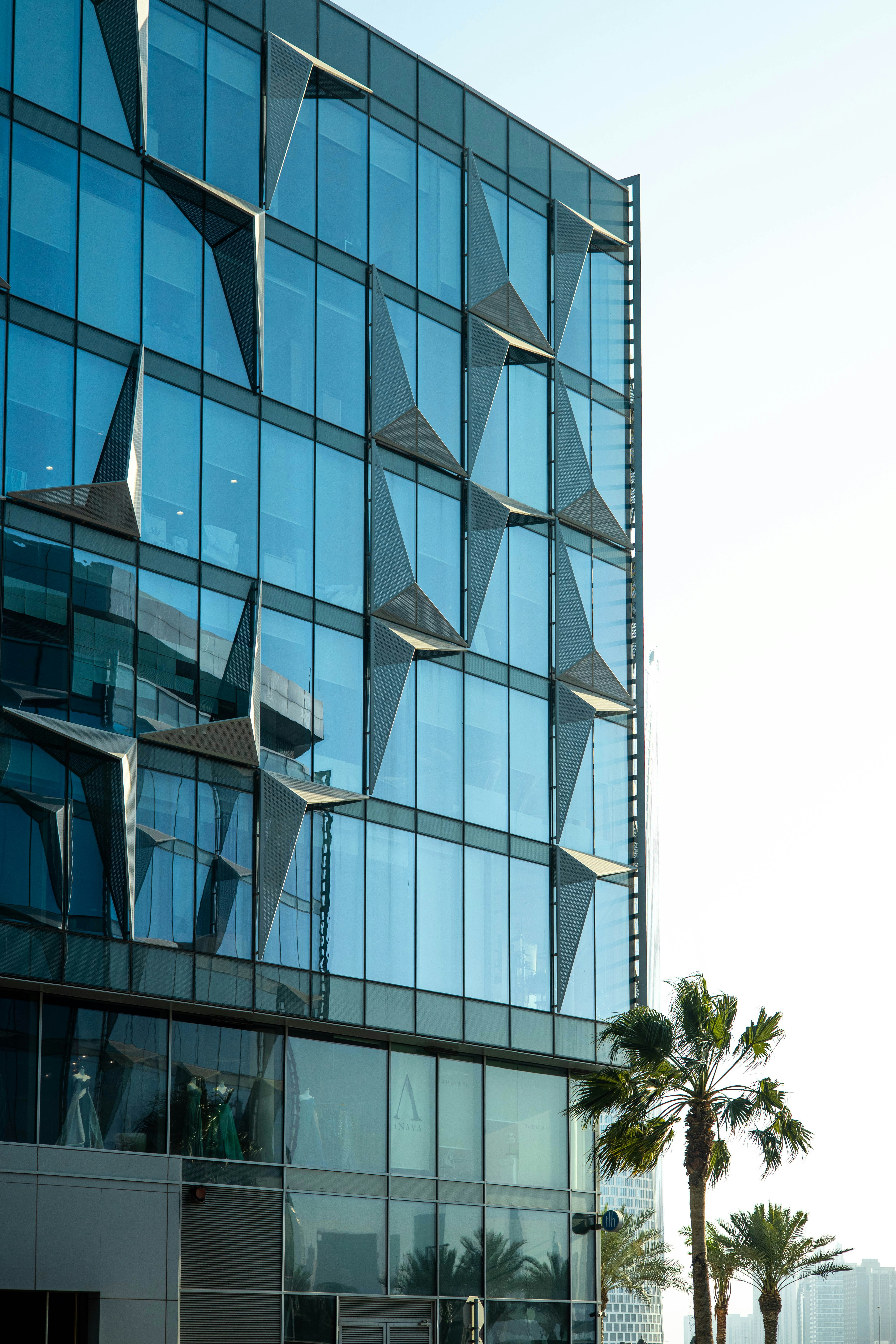 Facetwork Skyline: A Blue Glass Tower Forged in Geometric Light