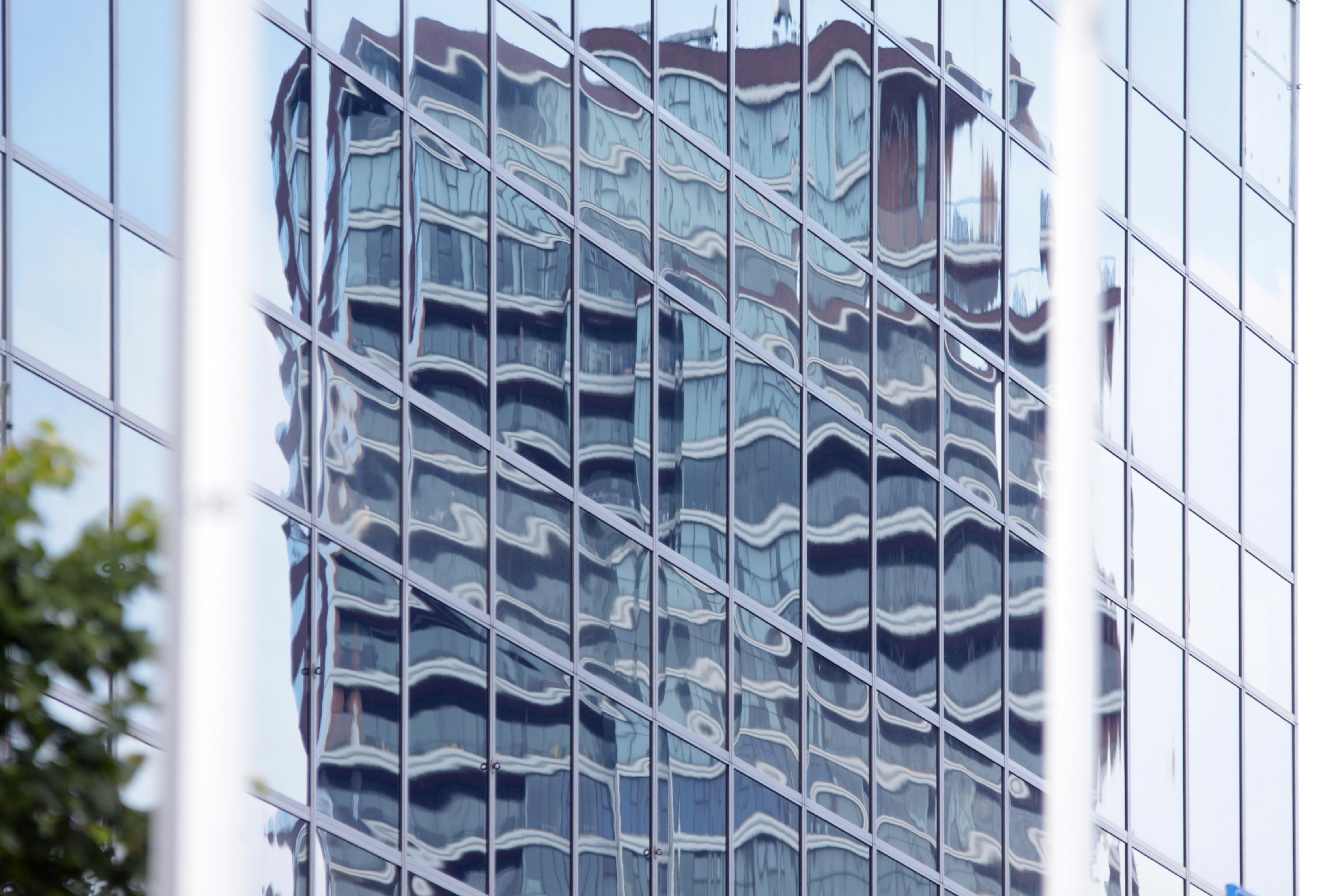 Wavering Skies: Distorted Reflections in a Glass Curtainwall