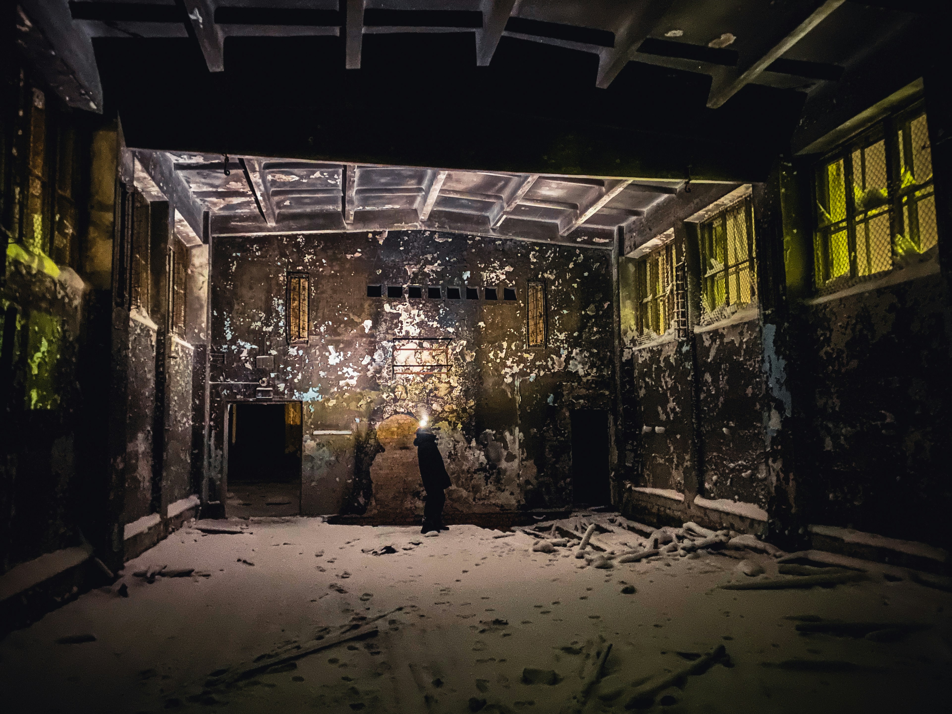 A person standing in an old run down building photo – Free Russia Image ...