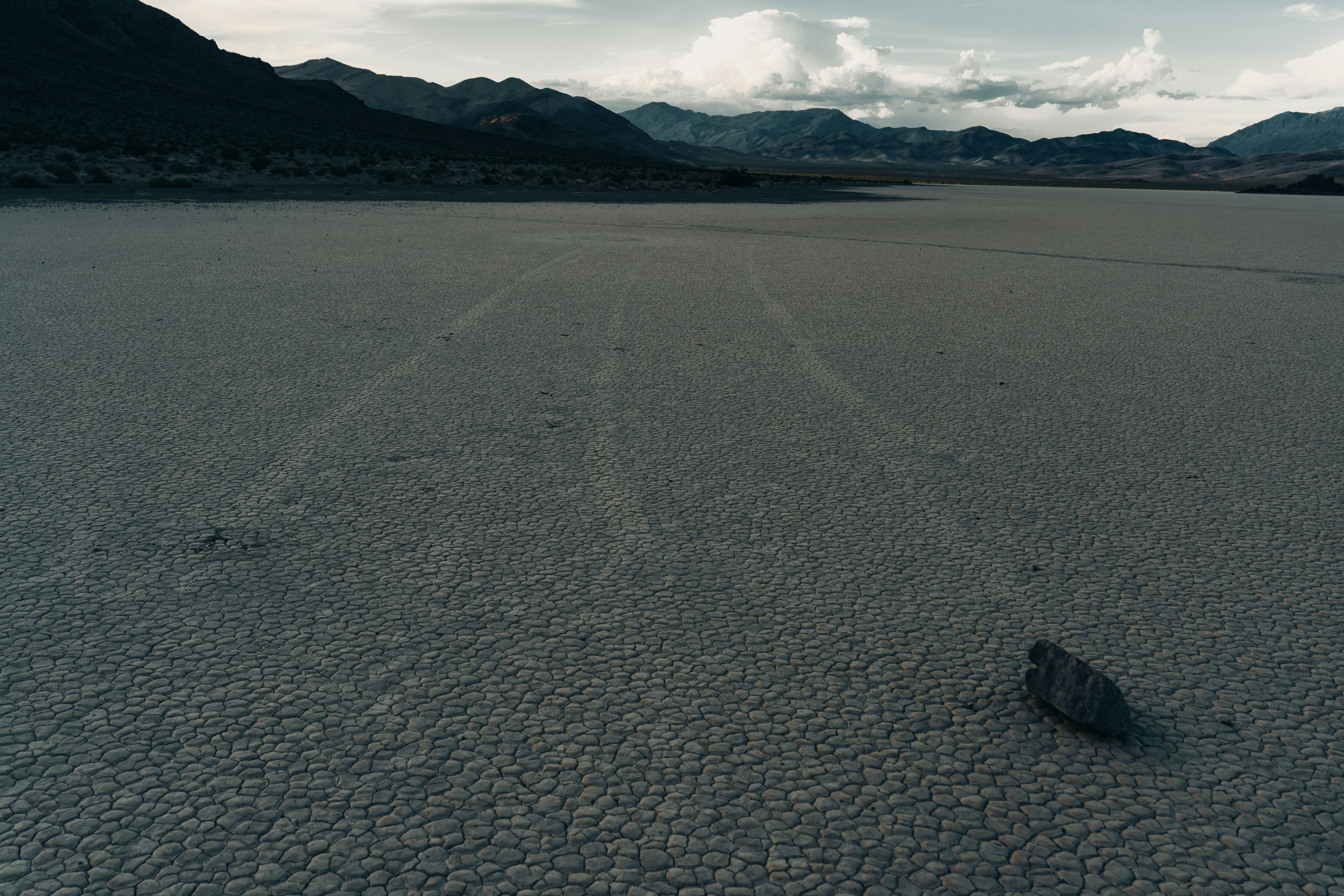 Cracked Salt Flats: Lone Rock and Distant Peaks