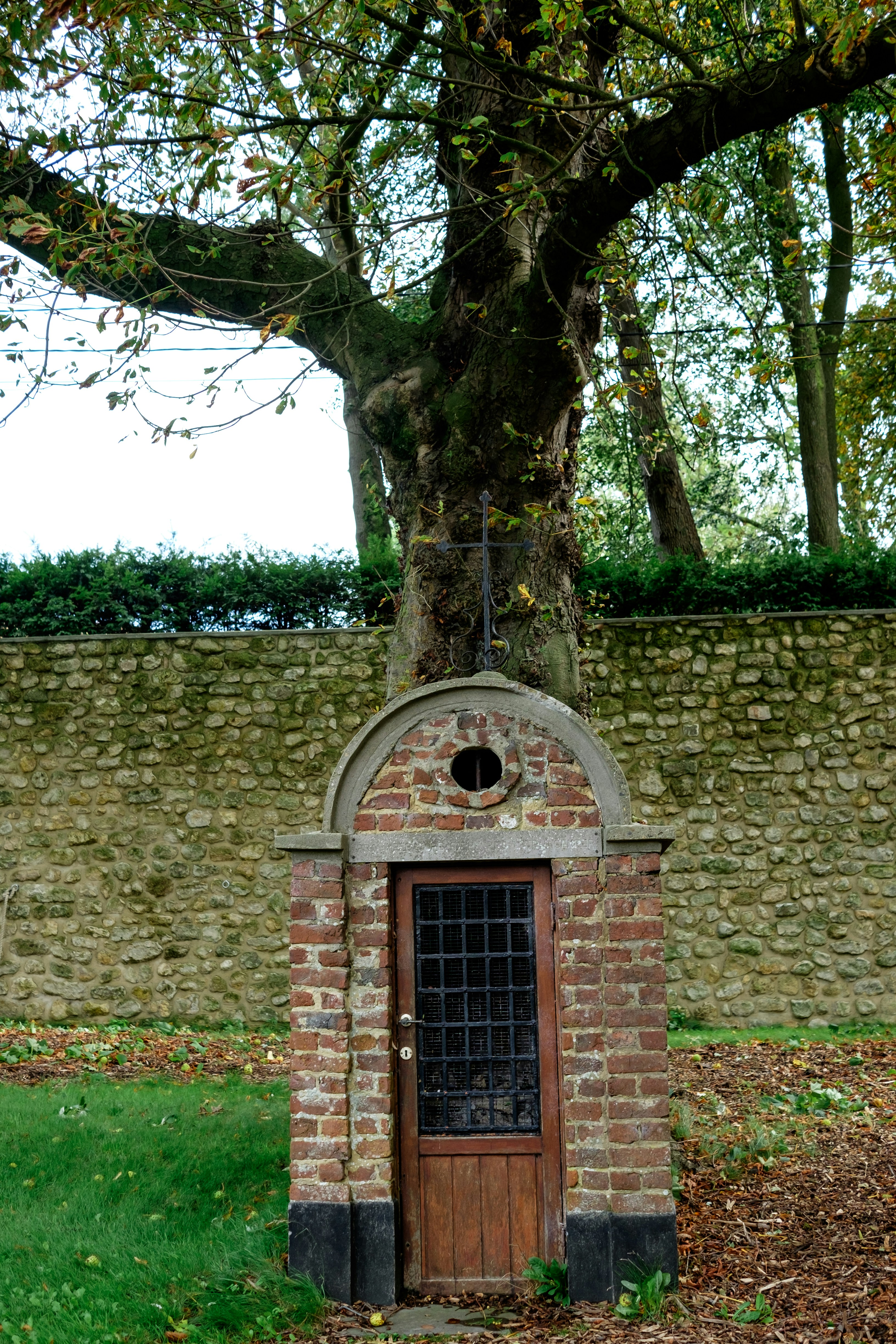 Brick Shrine Beneath a Gnarled Tree