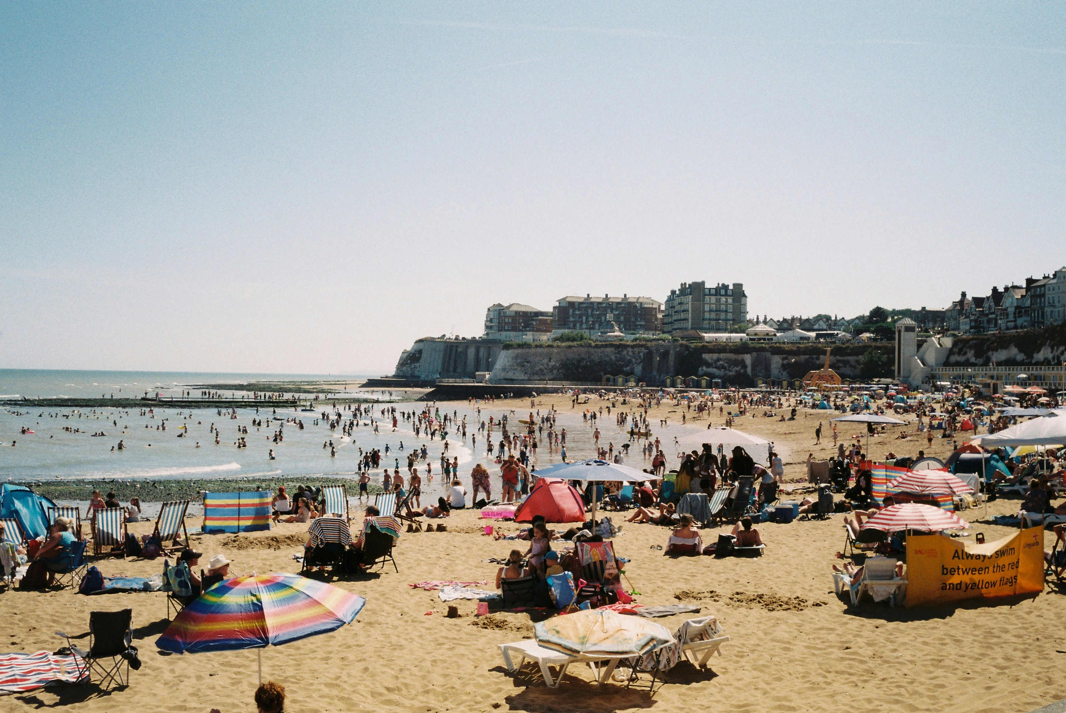 A crowded beach filled with lots of people photo – Free England Image ...