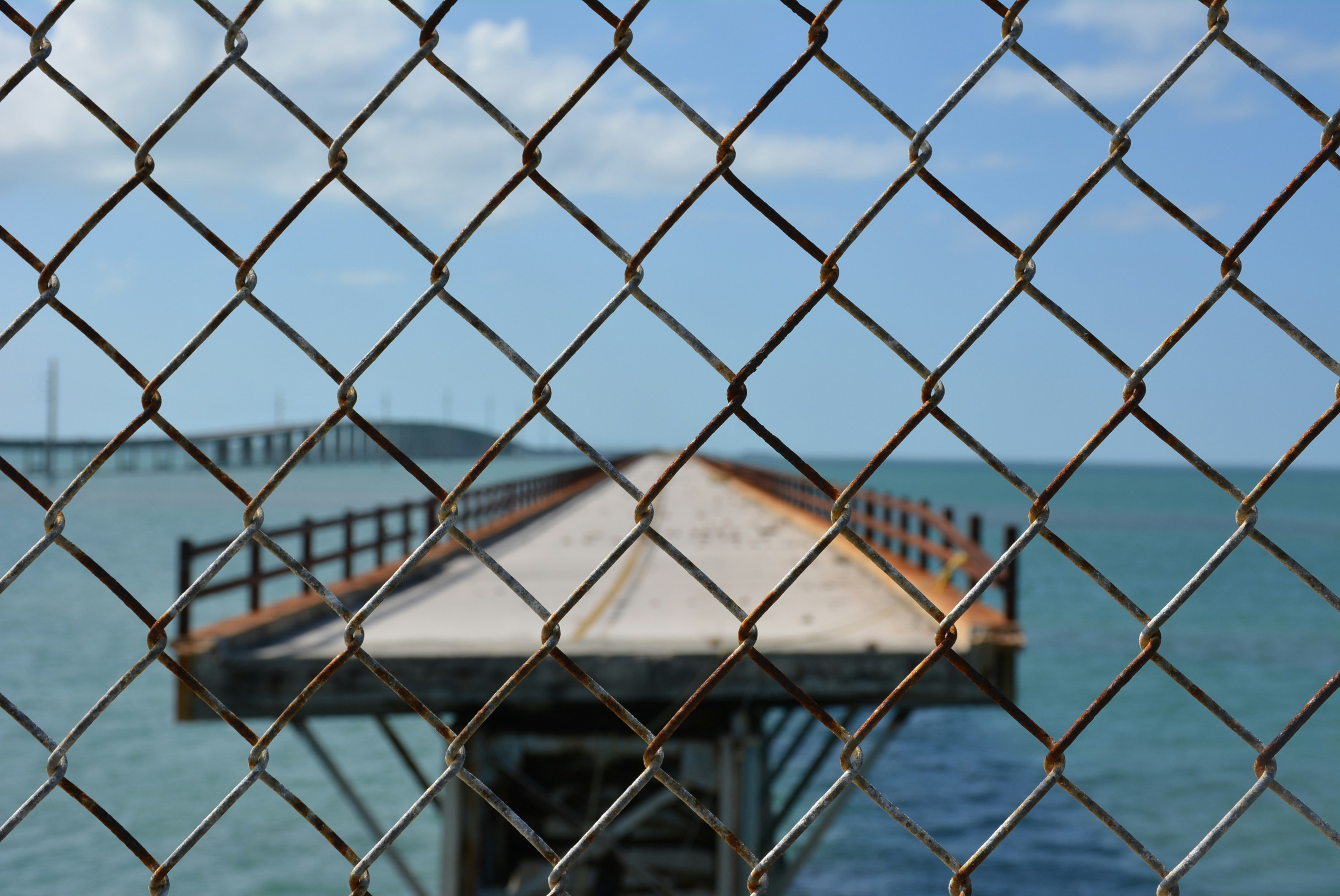 A view of a pier through a chain link fence photo – Free Seven mile ...