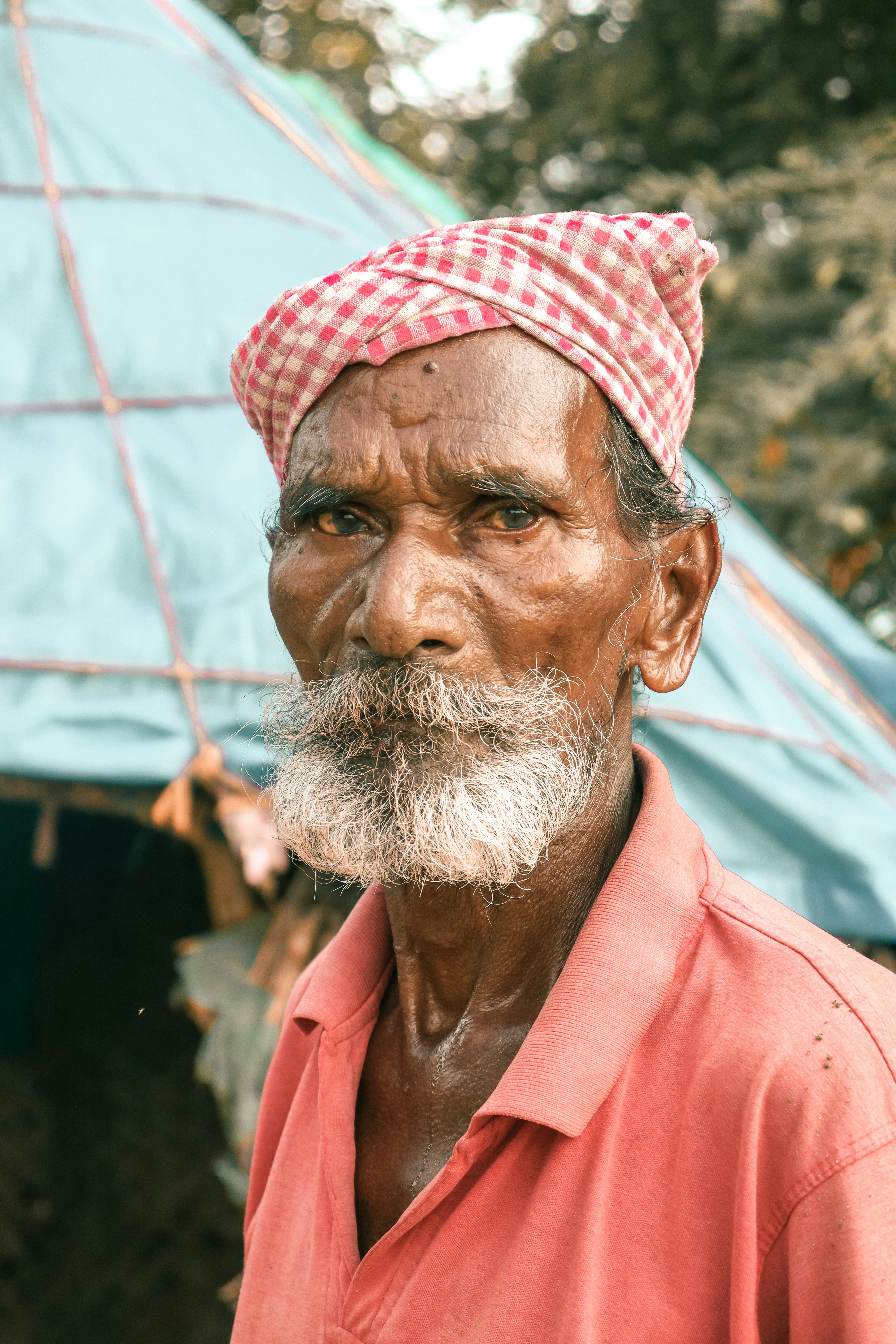 An old man with a red and white checkered hat photo – Free Old man ...
