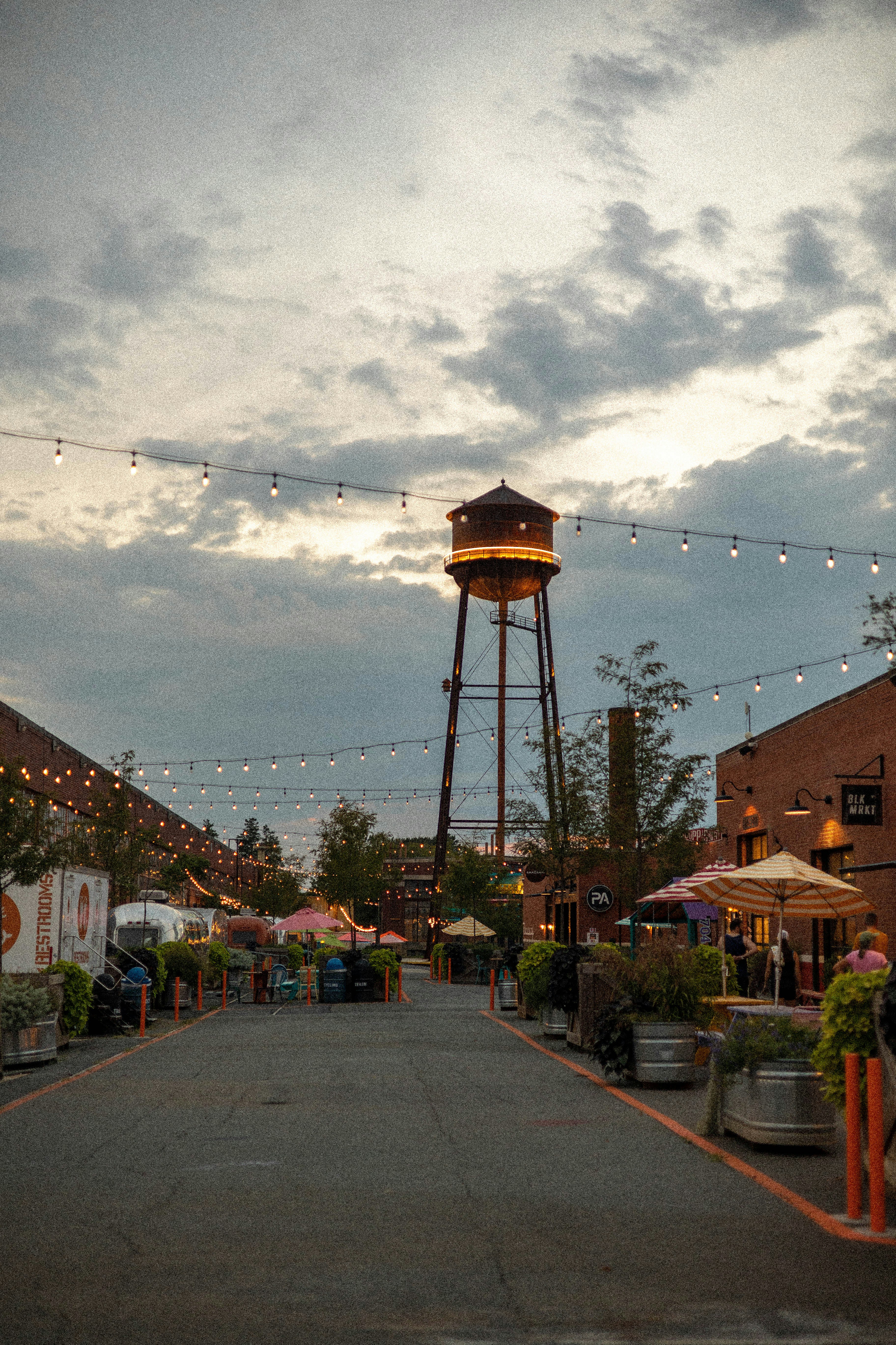 a street with a water tower in the background