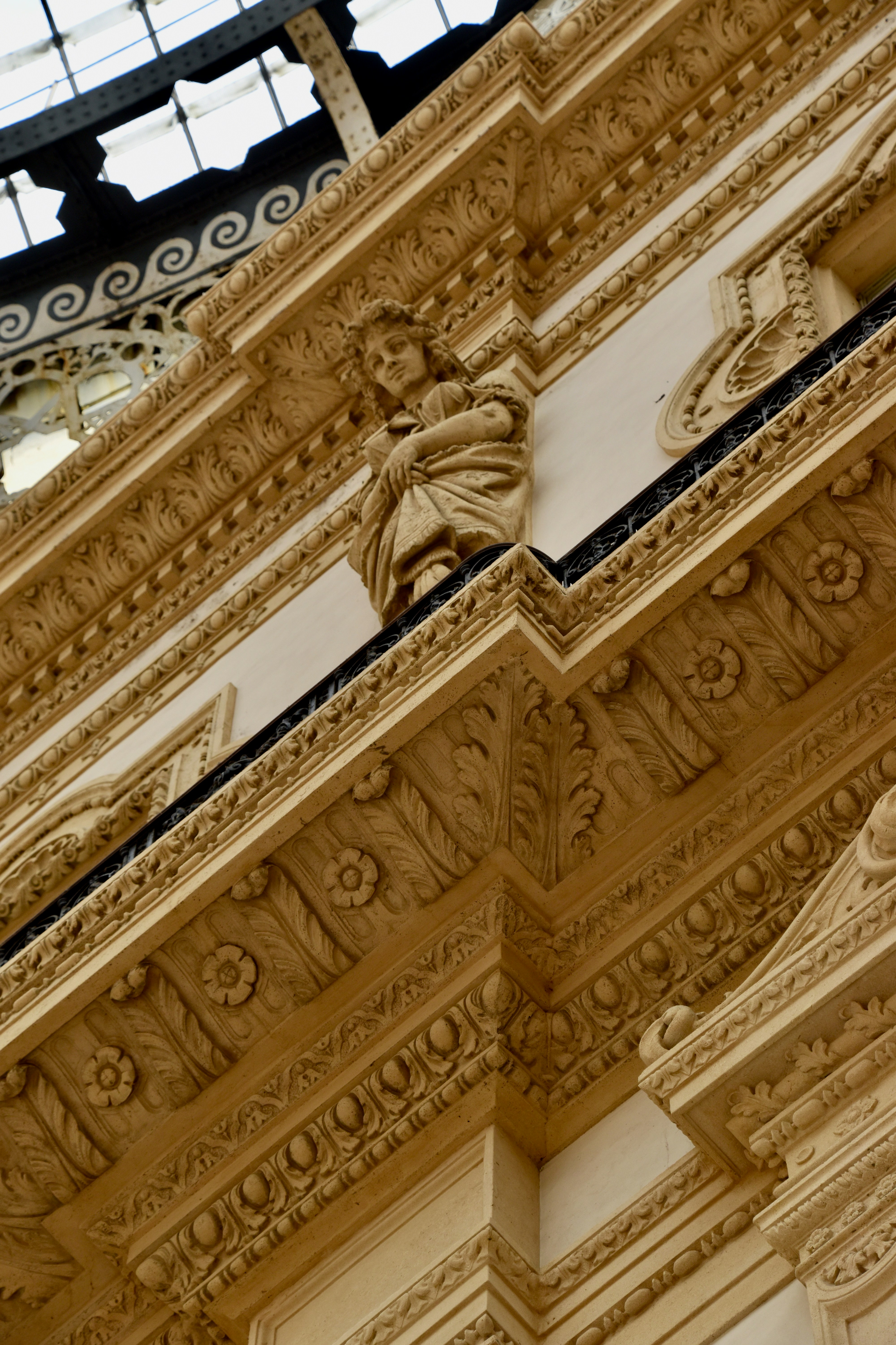 Intricate stone carvings and sculptures adorn a historic building's facade, showcasing classical artistry and craftsmanship.