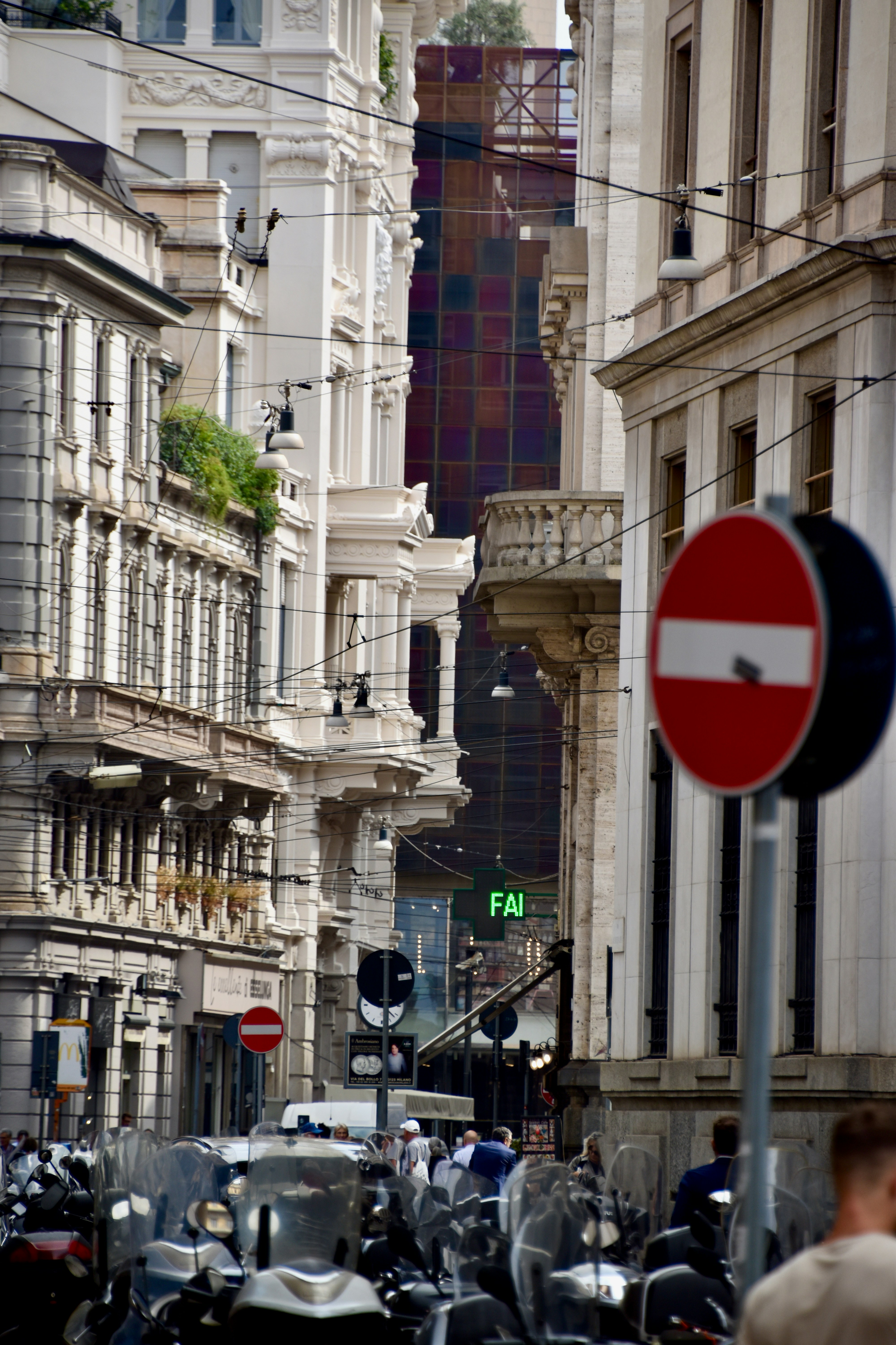 City Corridor: Narrow Street Framed by Historic Facades and a Red Circle Sign
