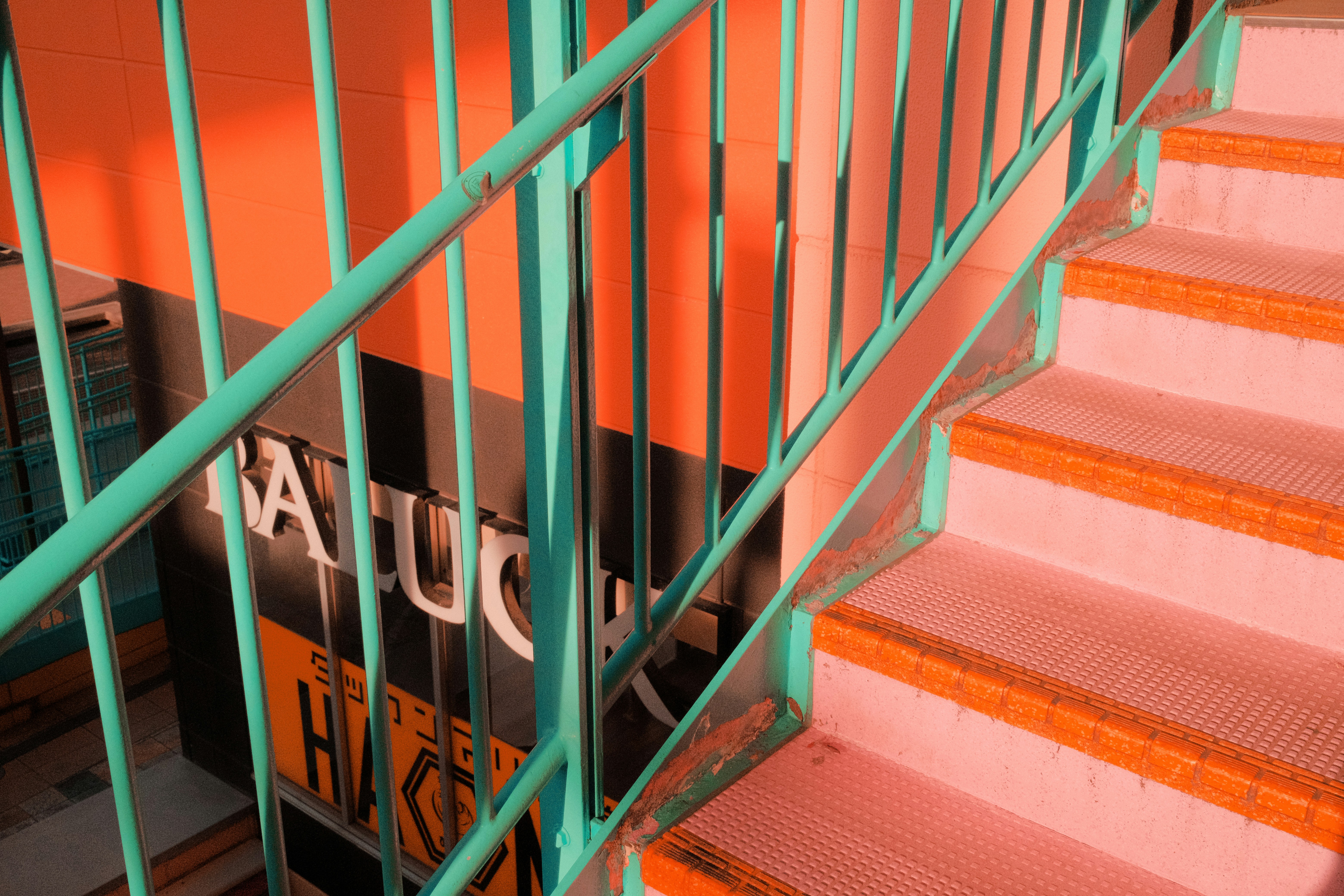 Teal Rails, Orange Walls: A Stairwell Geometry in Color