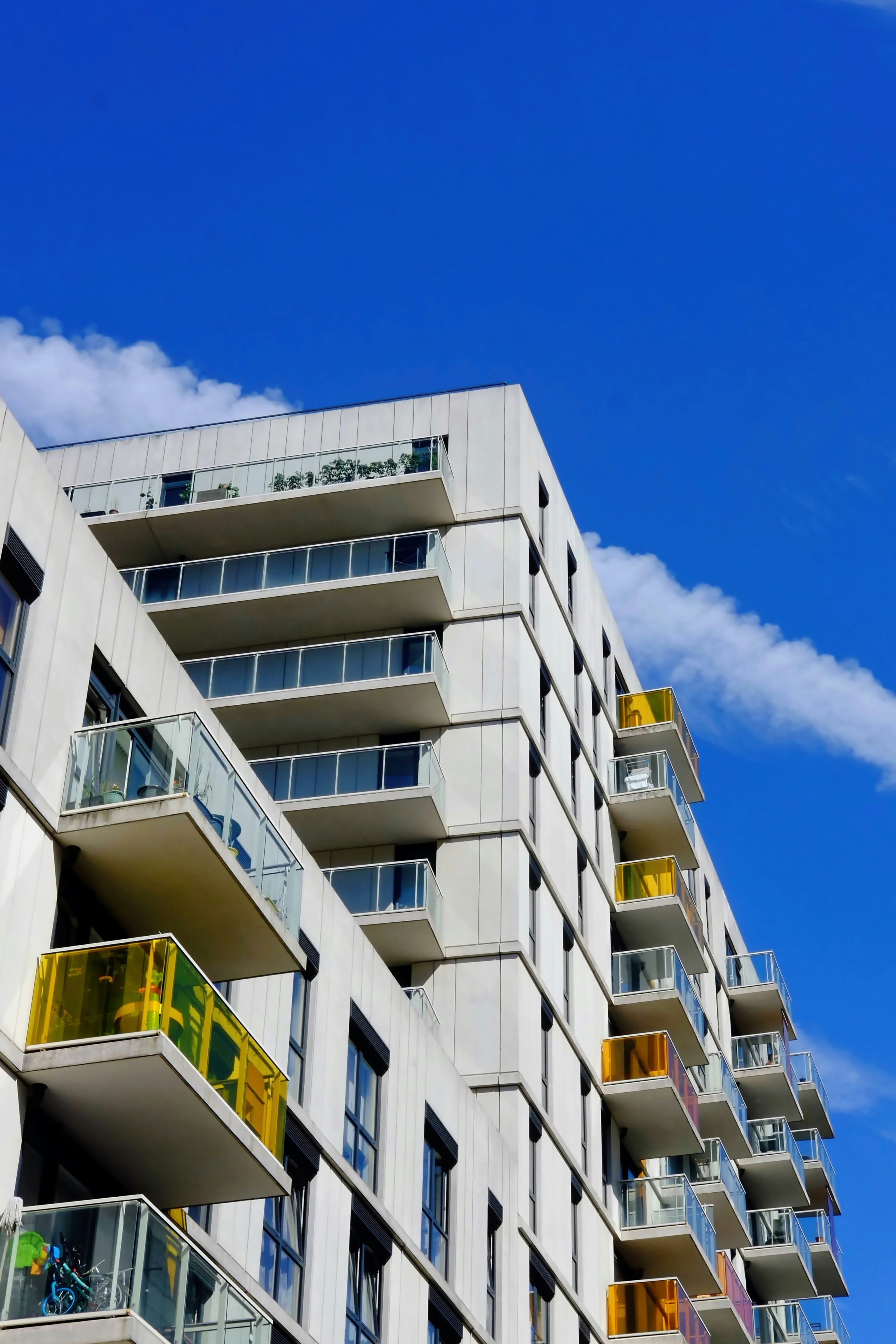 Apartment block against blue sky and cirrus cloud