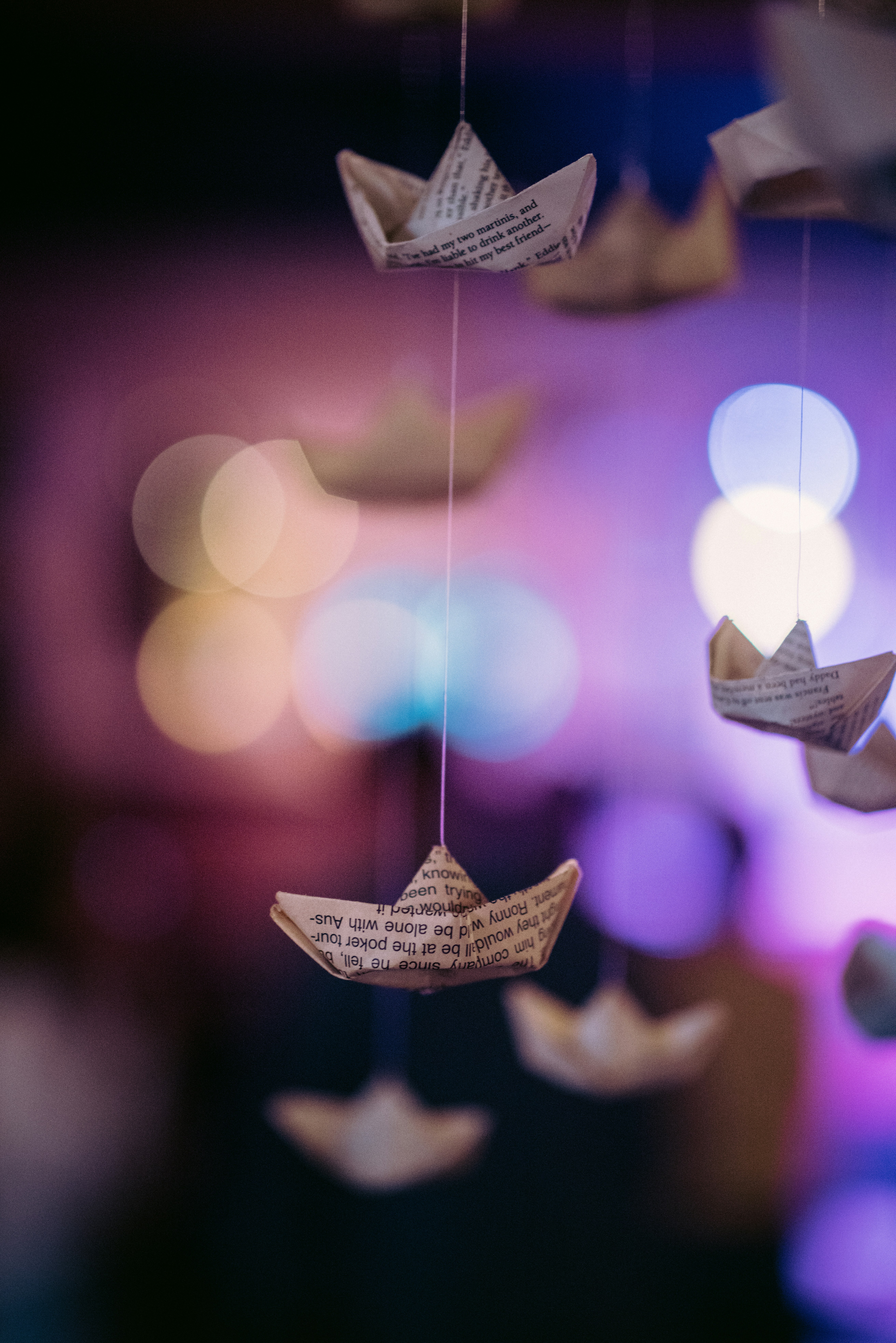 A group of origami boats hanging from strings photo – Free Symbol Image ...