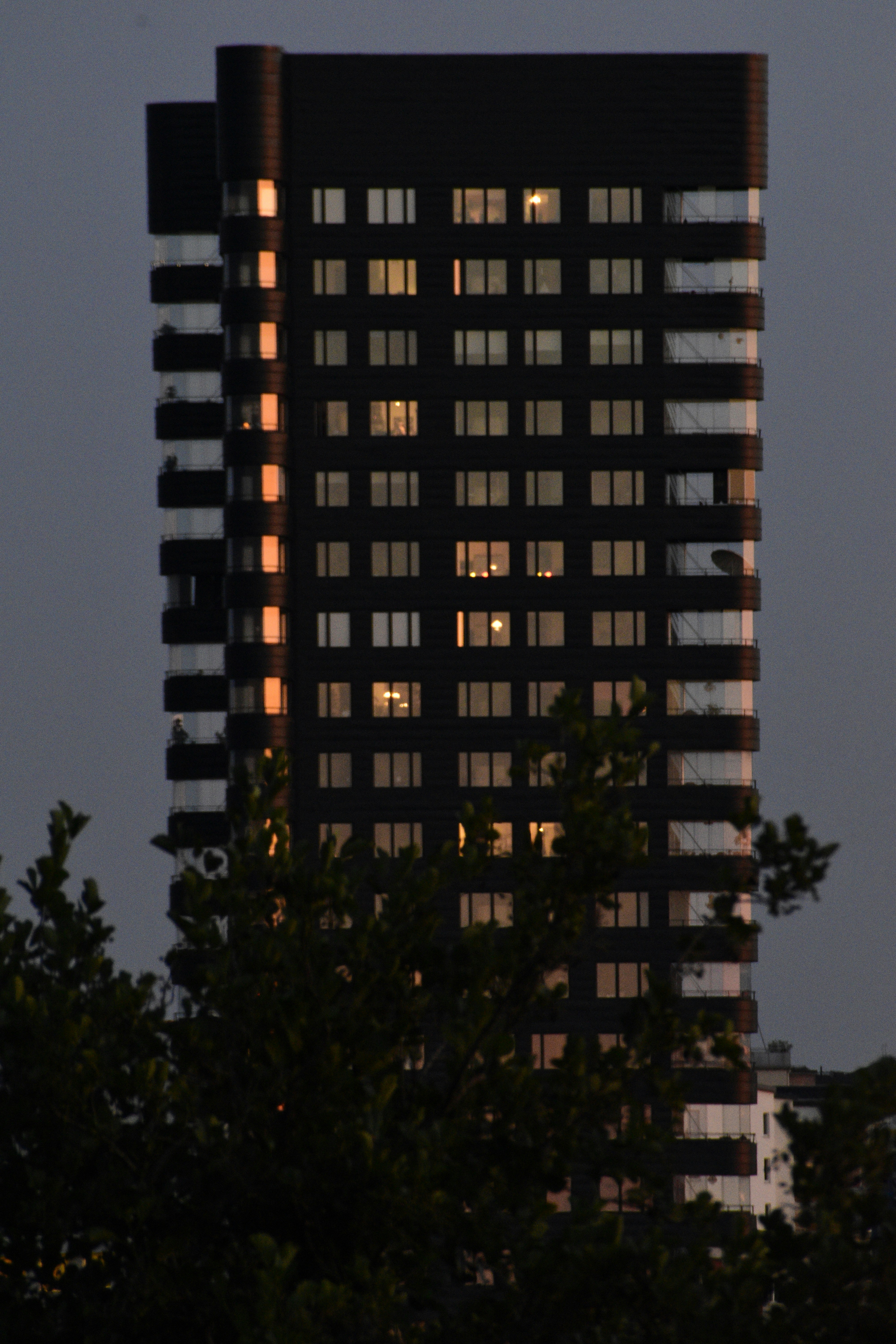 Dusk Facade: Warm Grid of Windows on a Silent High-Rise