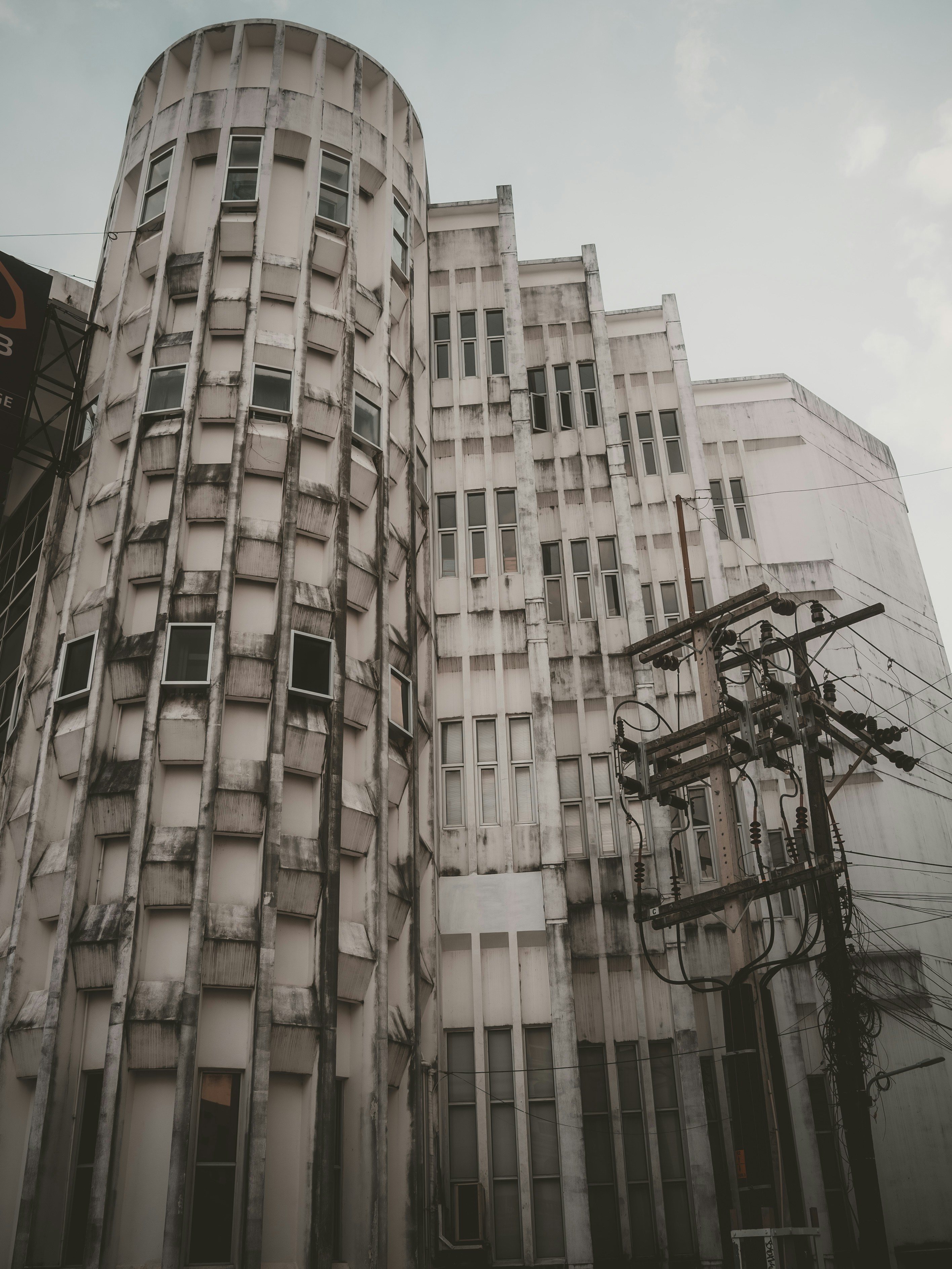 Round-Tower Reverie: Weathered Art Deco Facade Under Quiet Skies