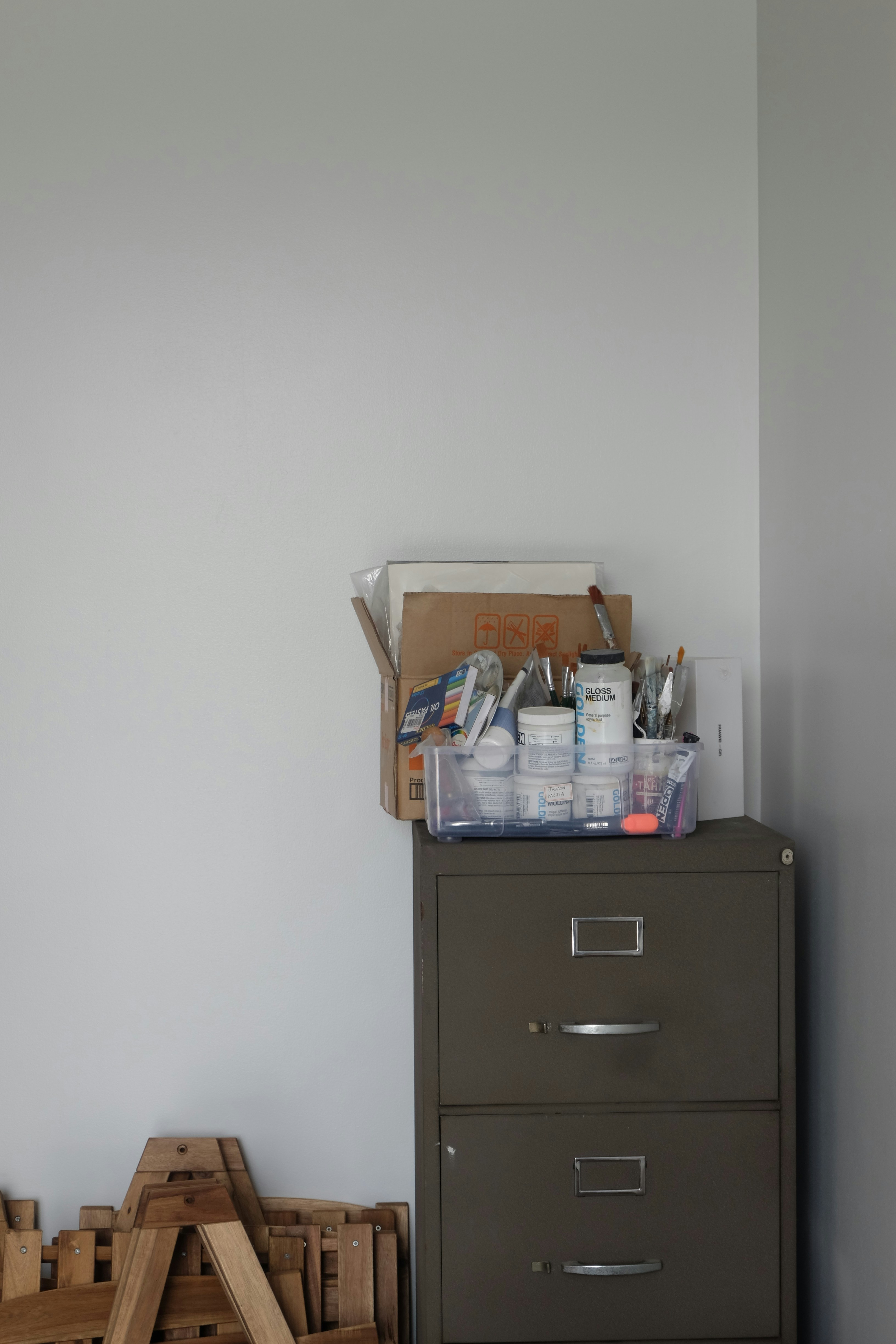 A filing cabinet sitting next to a pile of boxes photo – Free Art Image ...