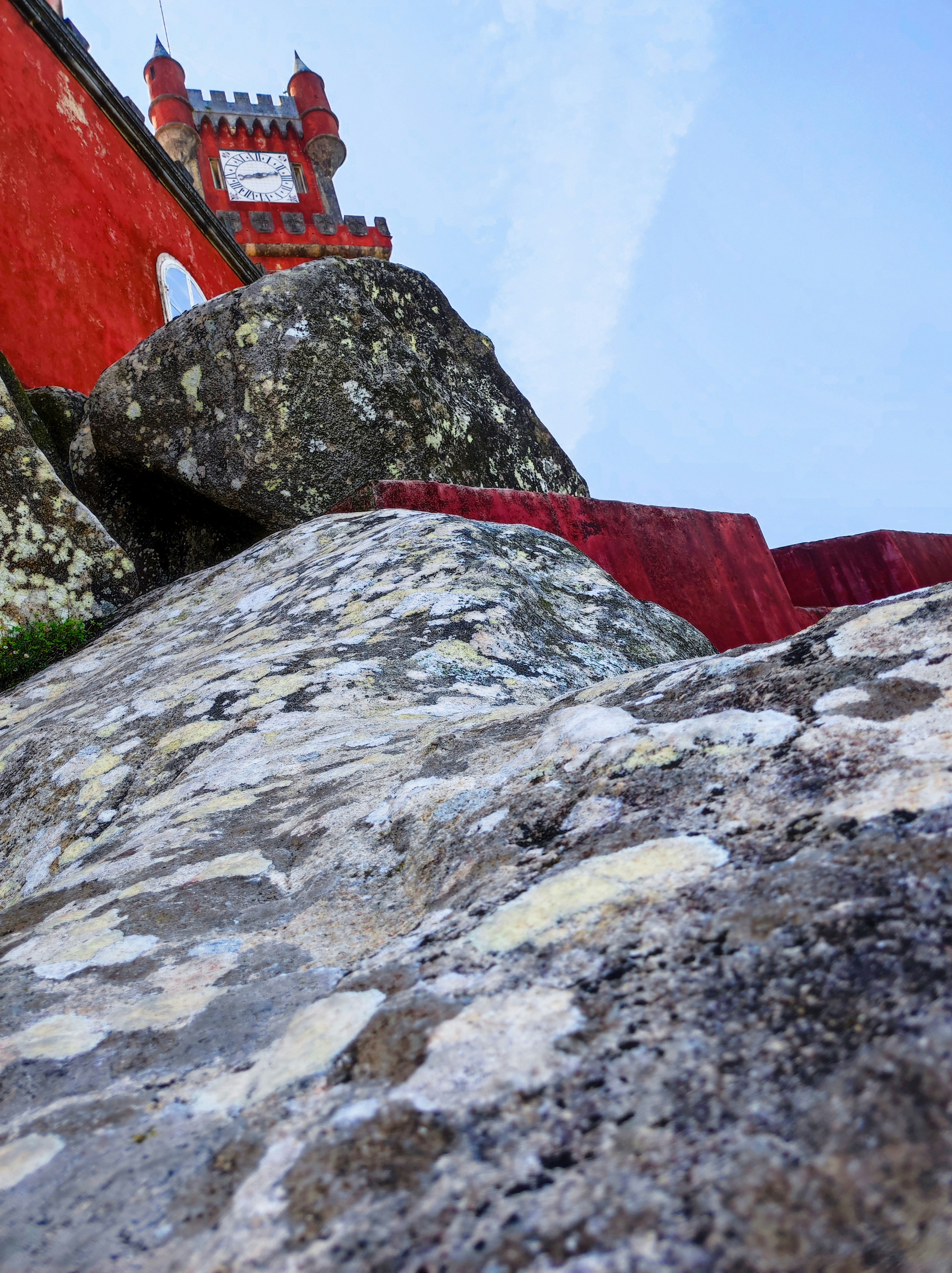 Red Bastion Above Weathered Granite Under a Clear Blue Sky
