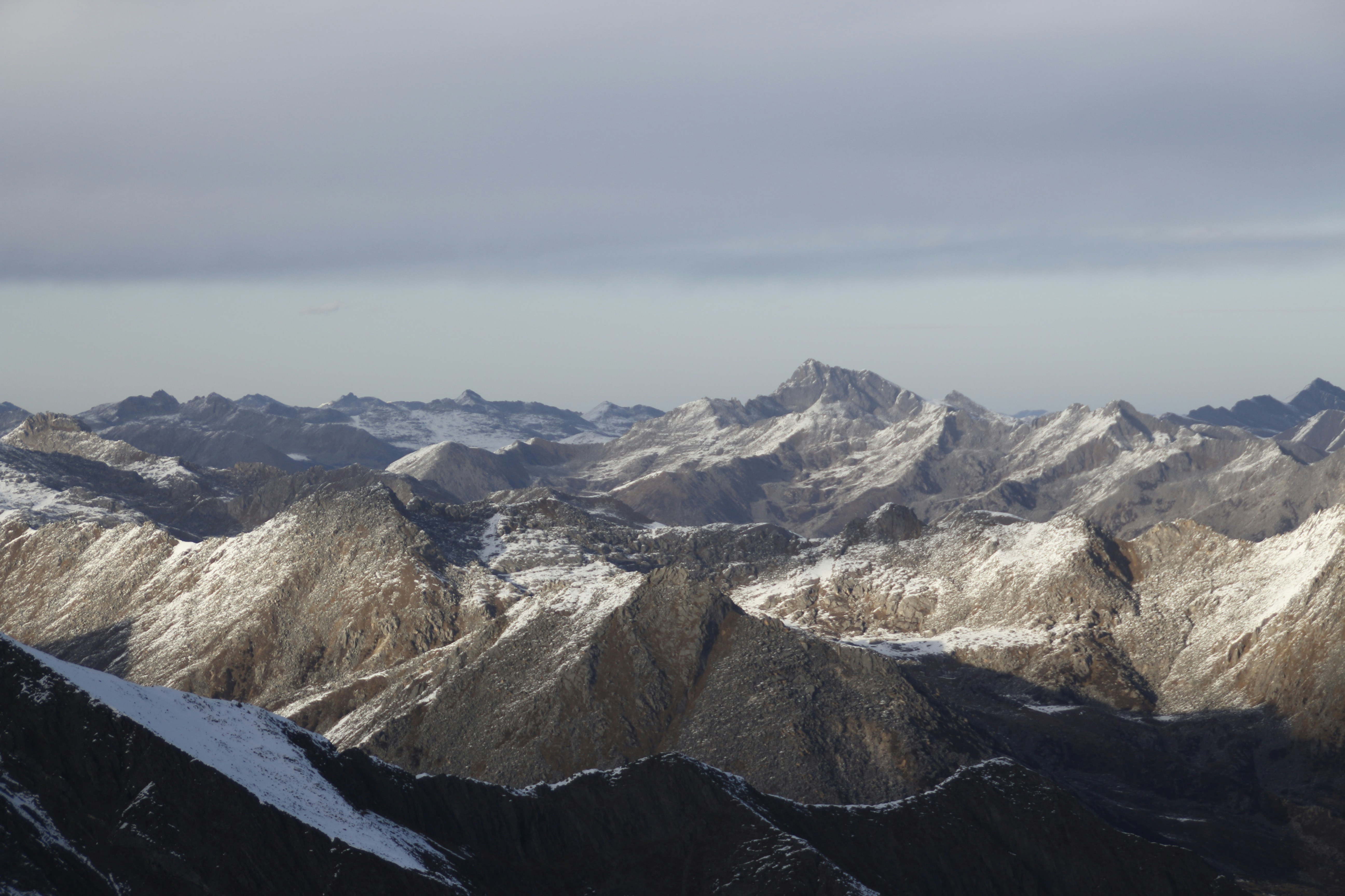 A view of a mountain range covered in snow photo – Free Scenery Image ...