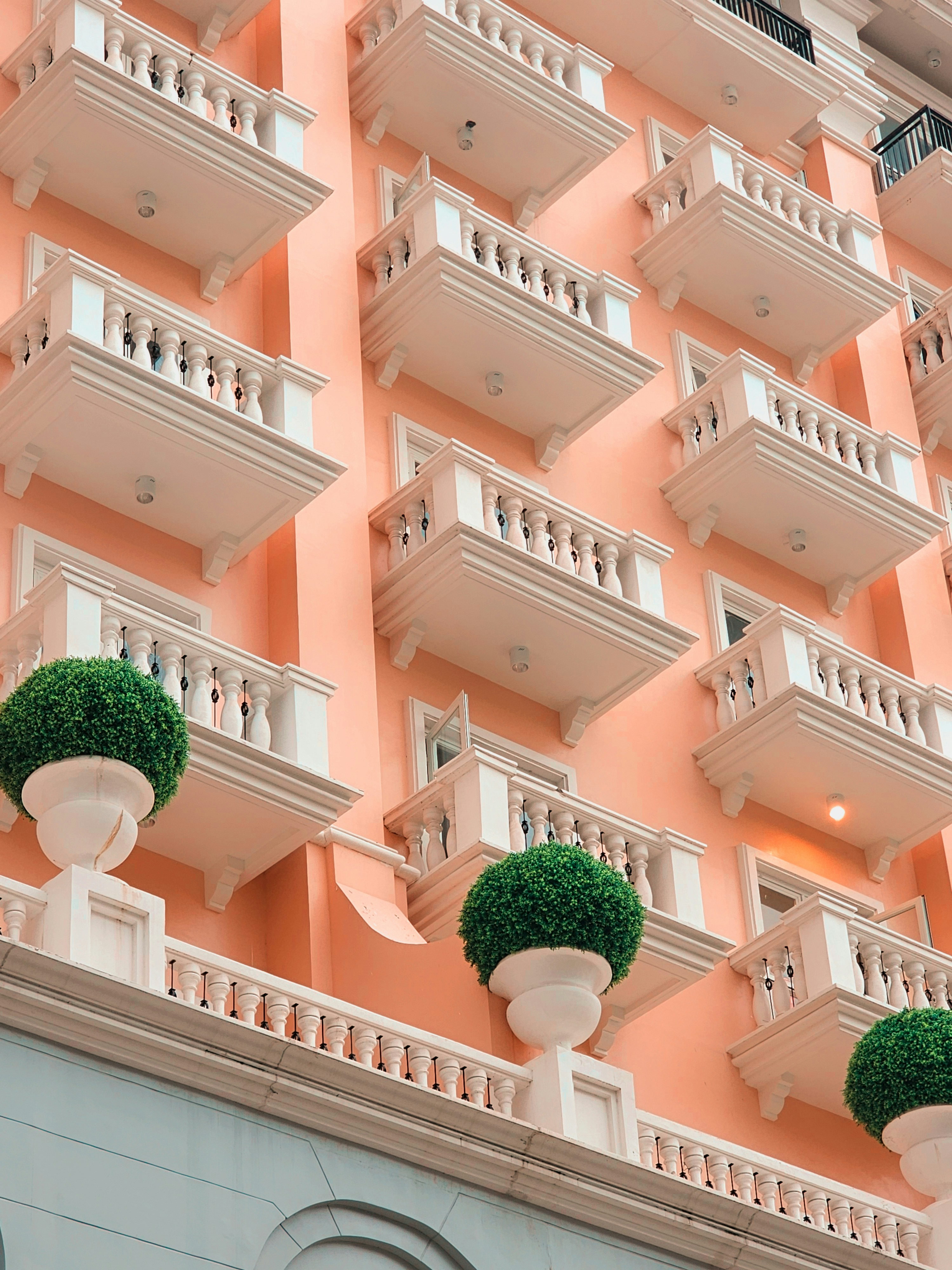 A tall building with balconies and balconies on the balconies photo ...