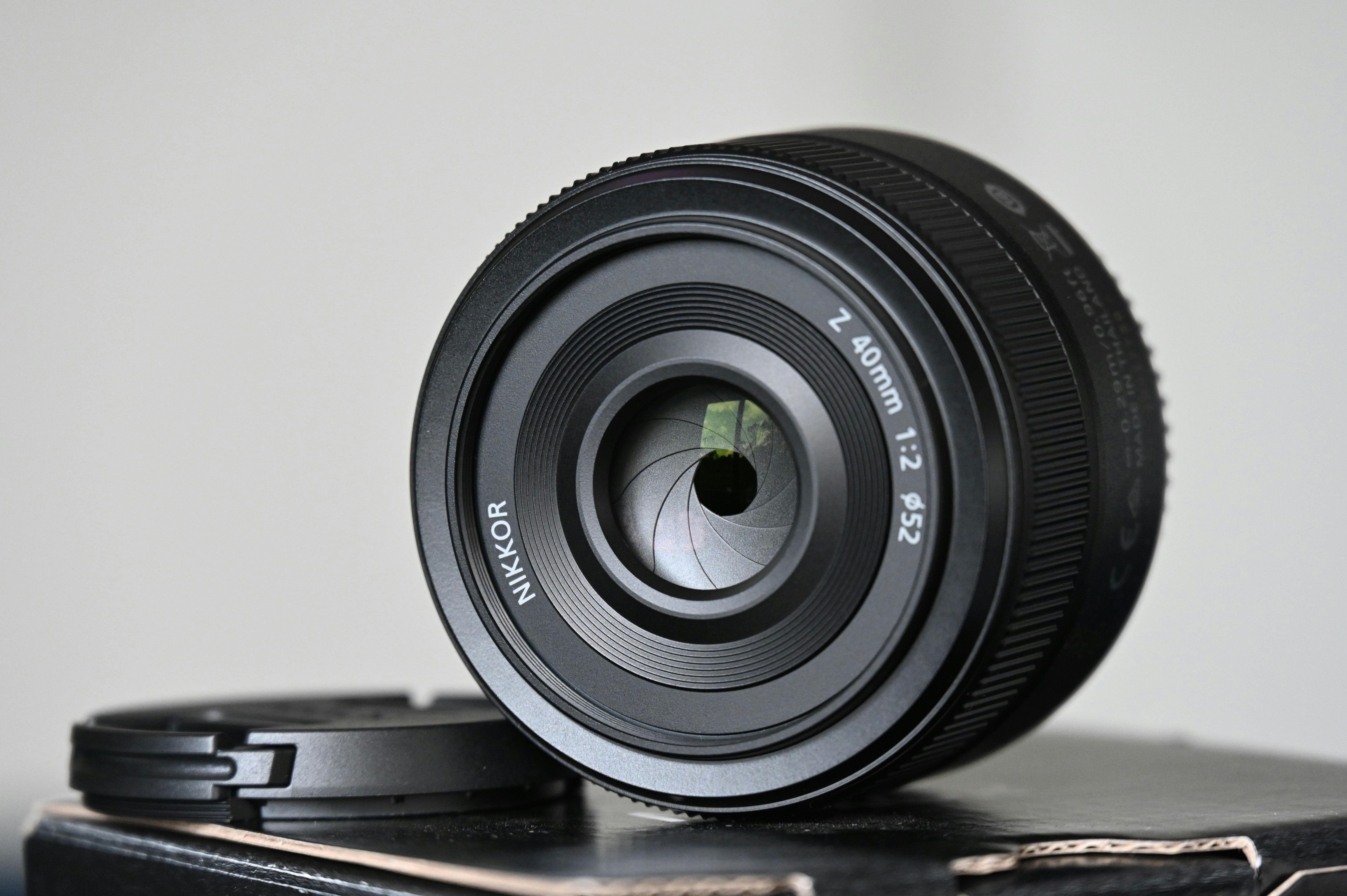 A camera lens sitting on top of a black case photo – Free Photo Image ...