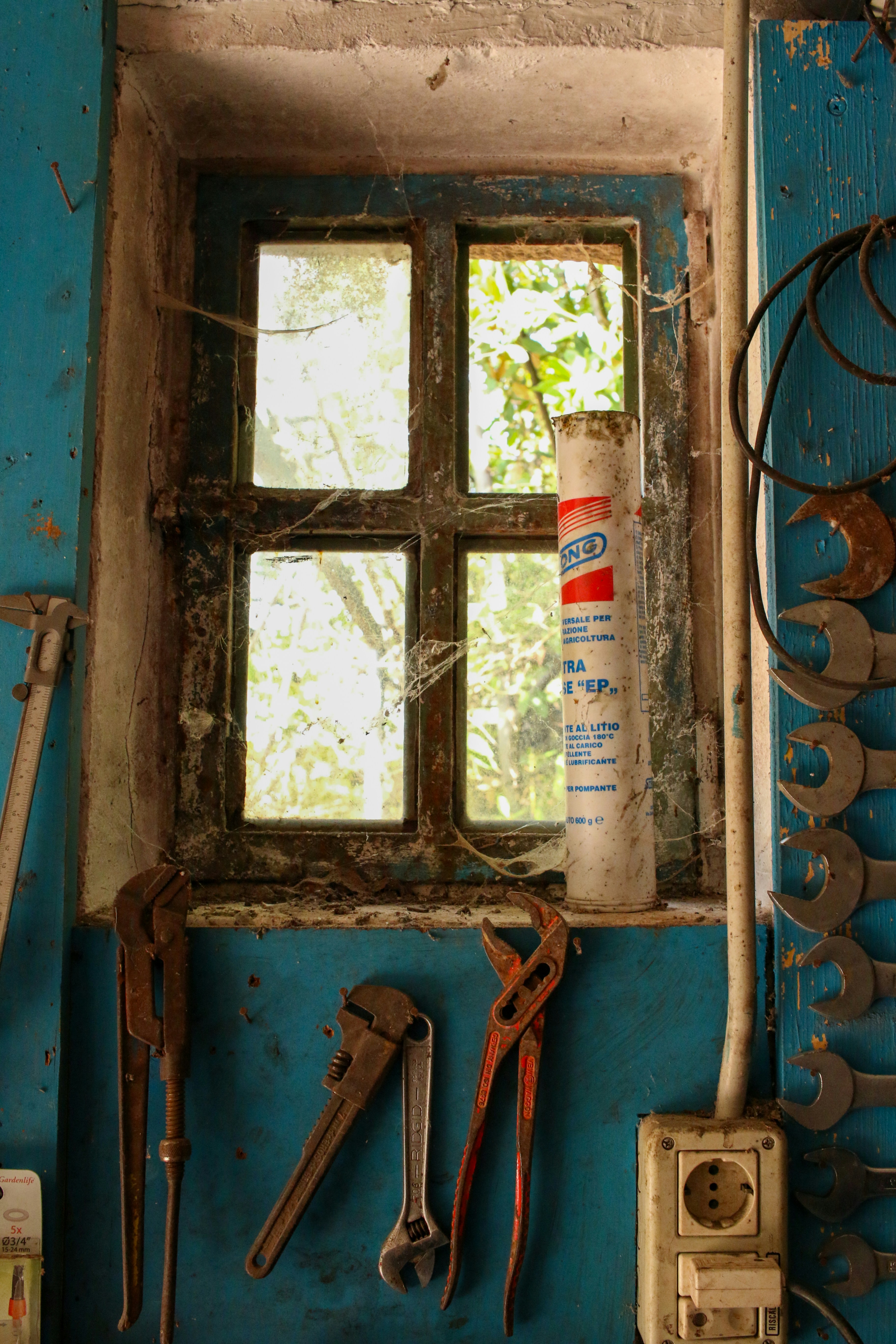 Rust and Light in a Workshop Window