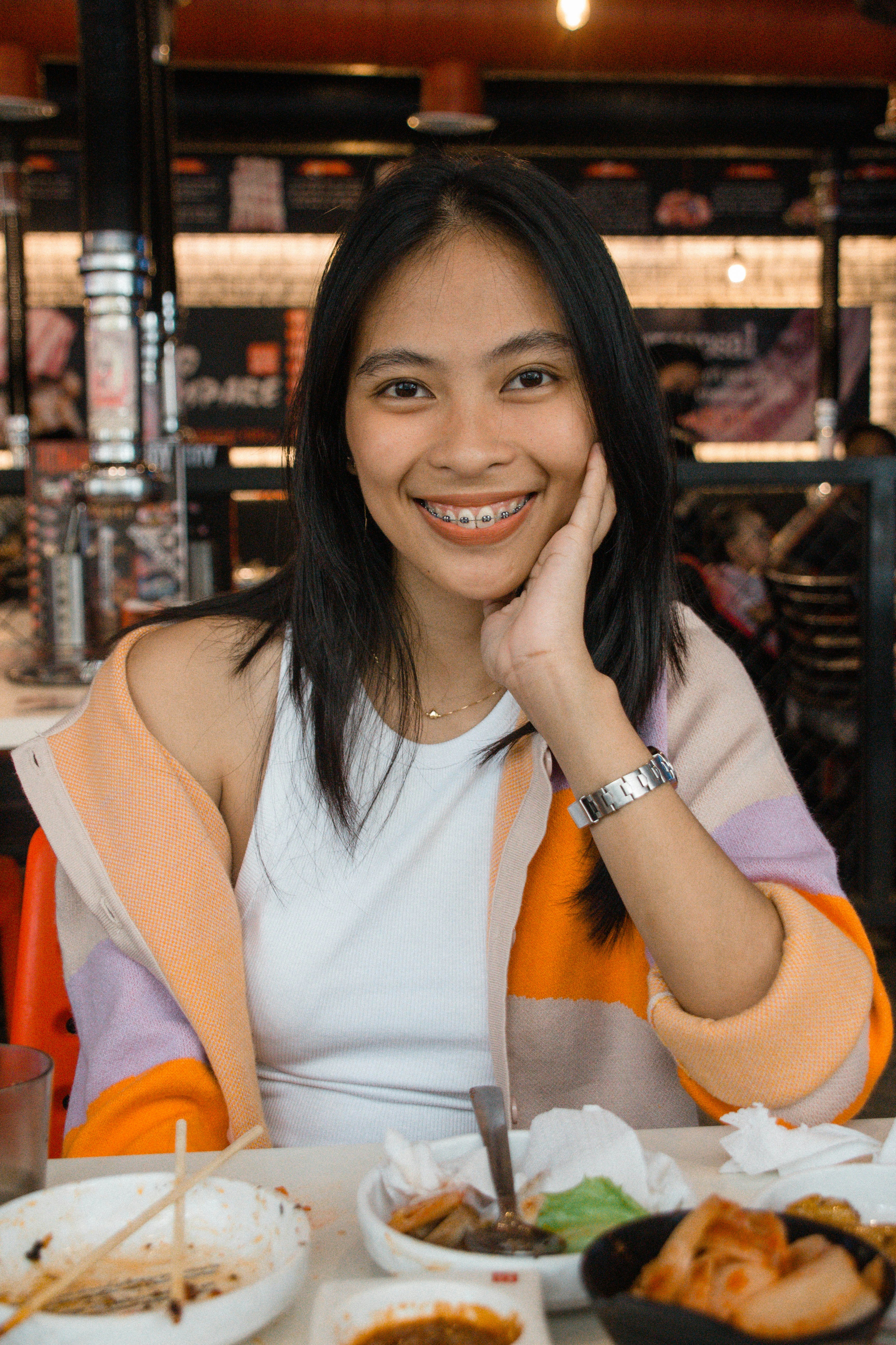 Warm Bistro Glow and a Bright Smile: Portrait at a Cozy Café