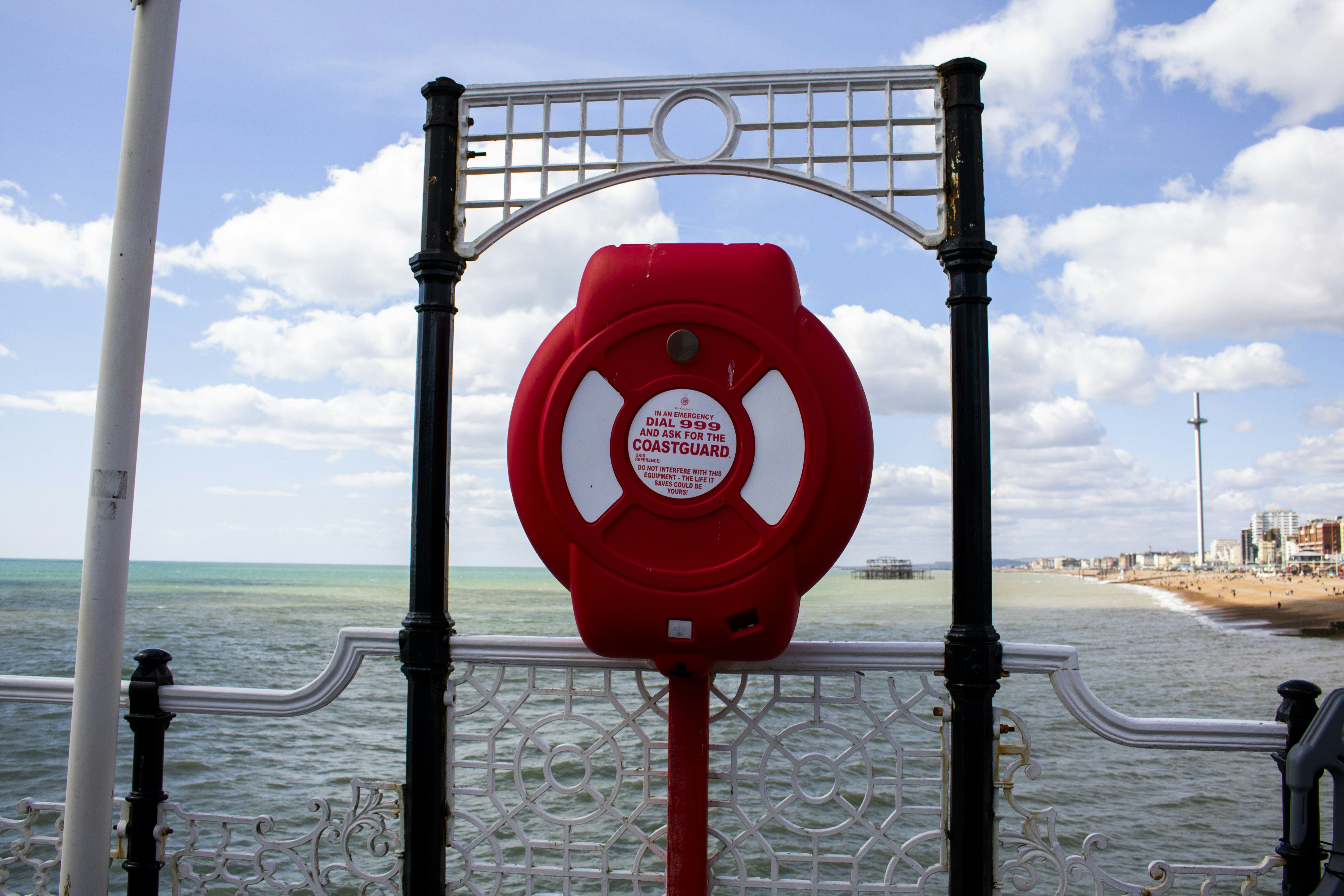 Crimson Lifebuoy Framing the Seaside Horizon