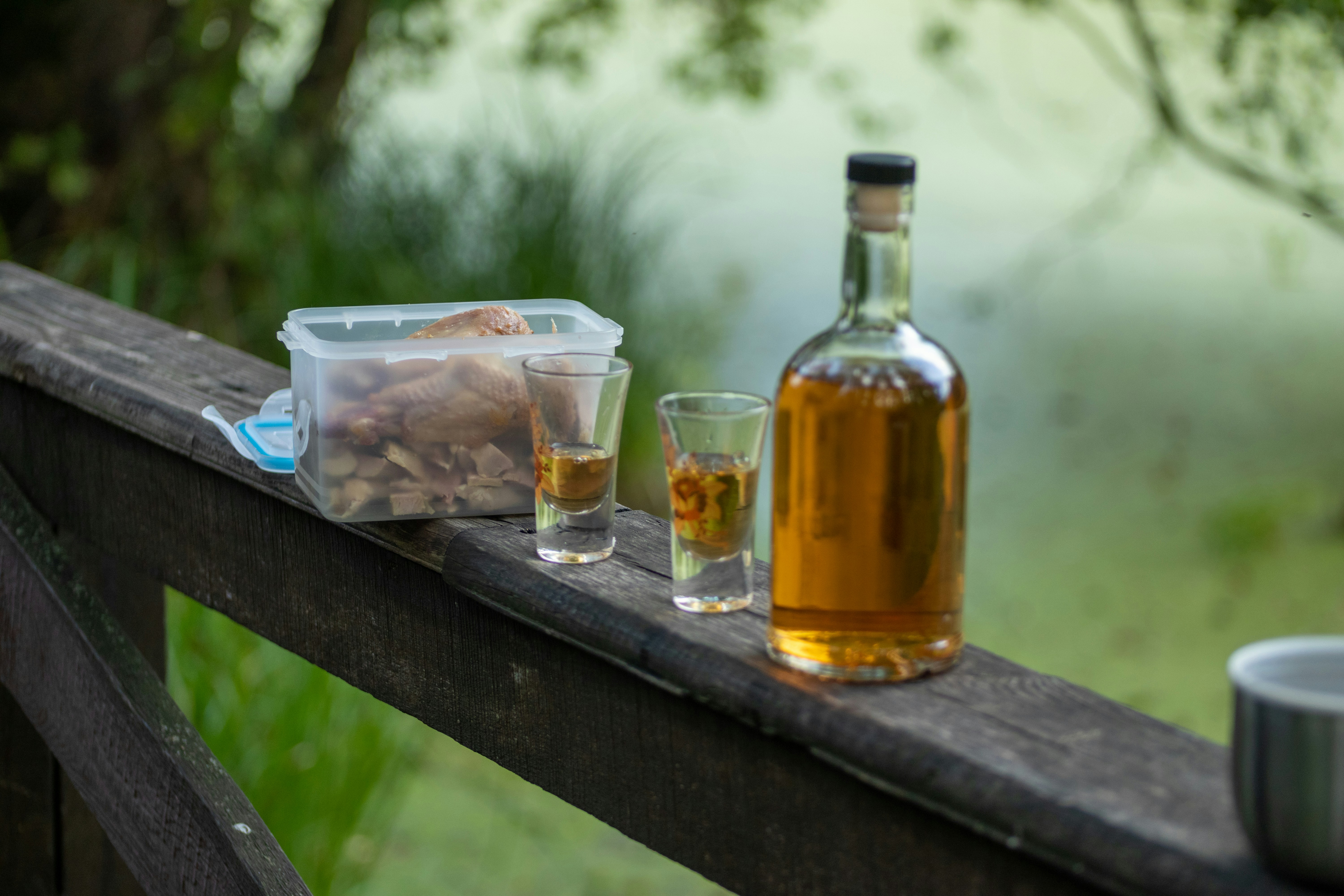 A bottle of wine and a glass on a wooden rail photo – Free Alcohol ...