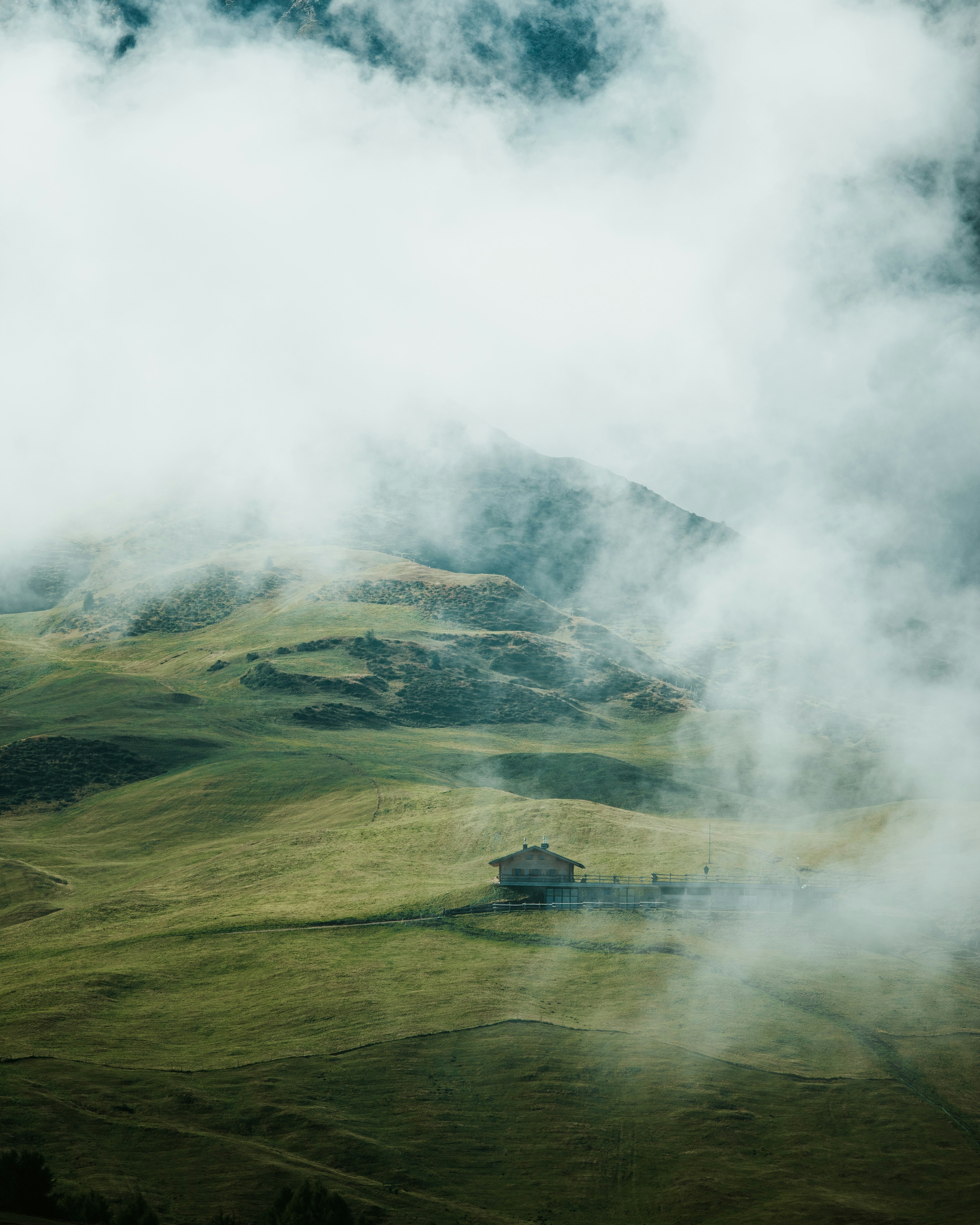 A house in the middle of a grassy field photo – Free Seiser alm Image ...
