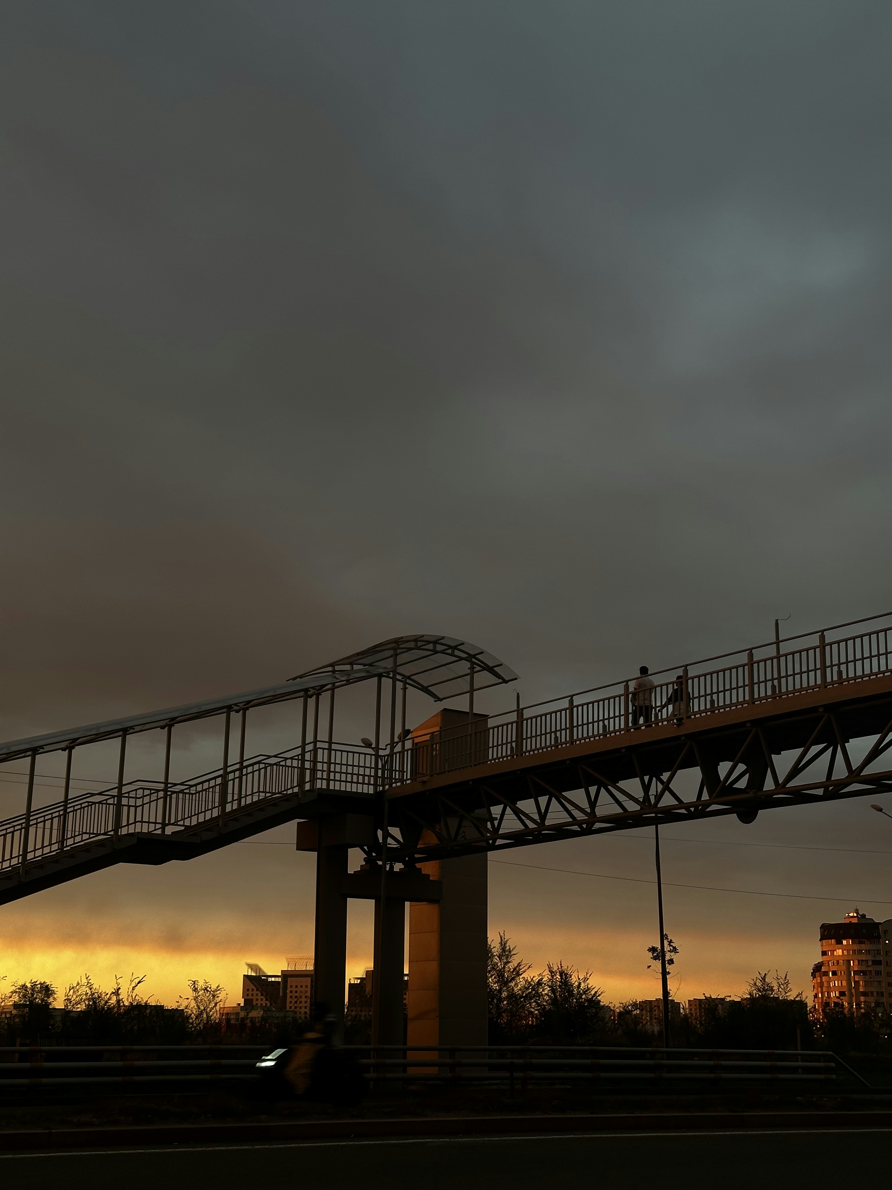 A bridge with a person walking across it photo – Free Road Image on ...