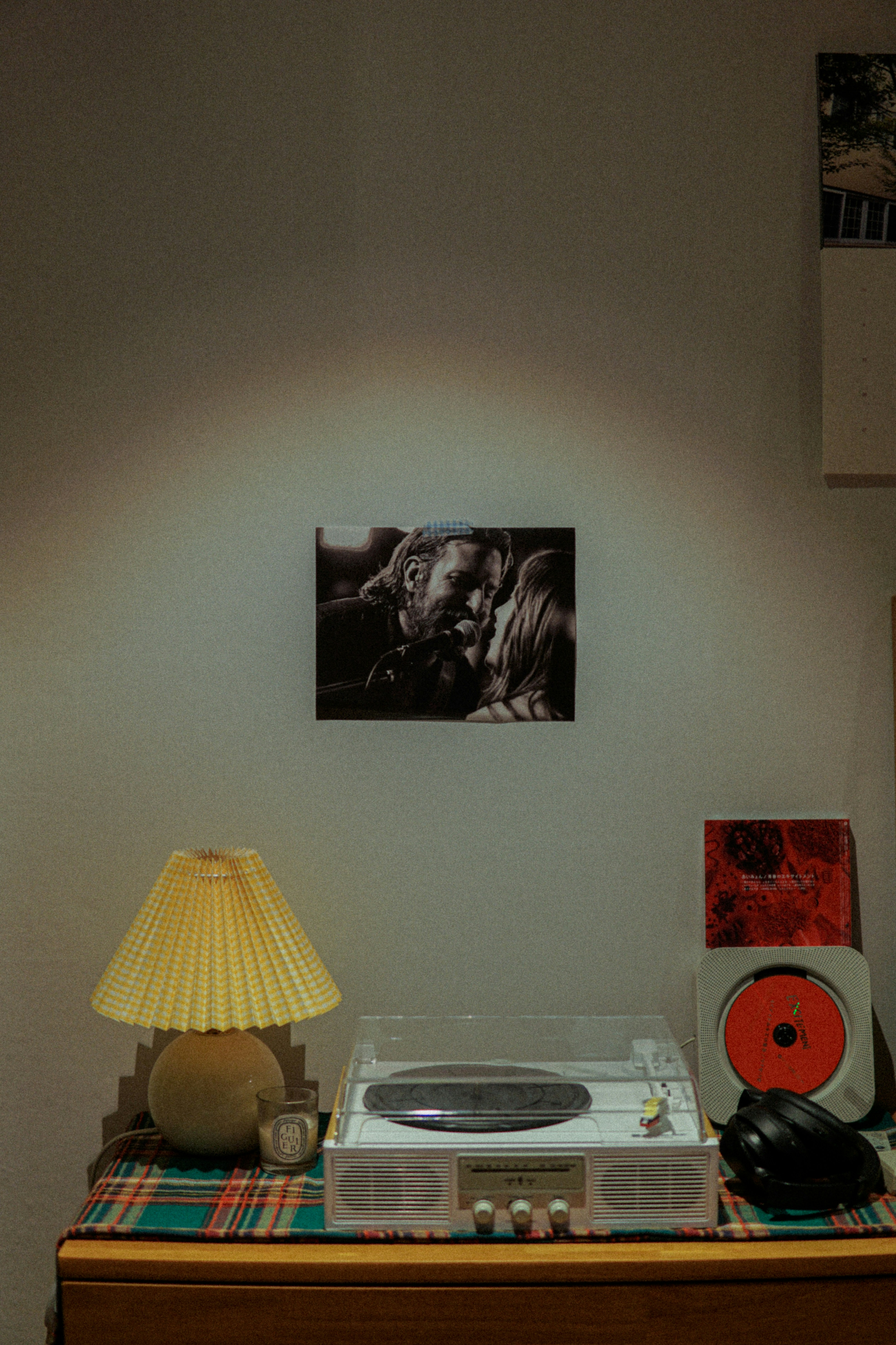 Haloed Vinyl: A Cozy Plaid Corner with Turntable and Wall Photo
