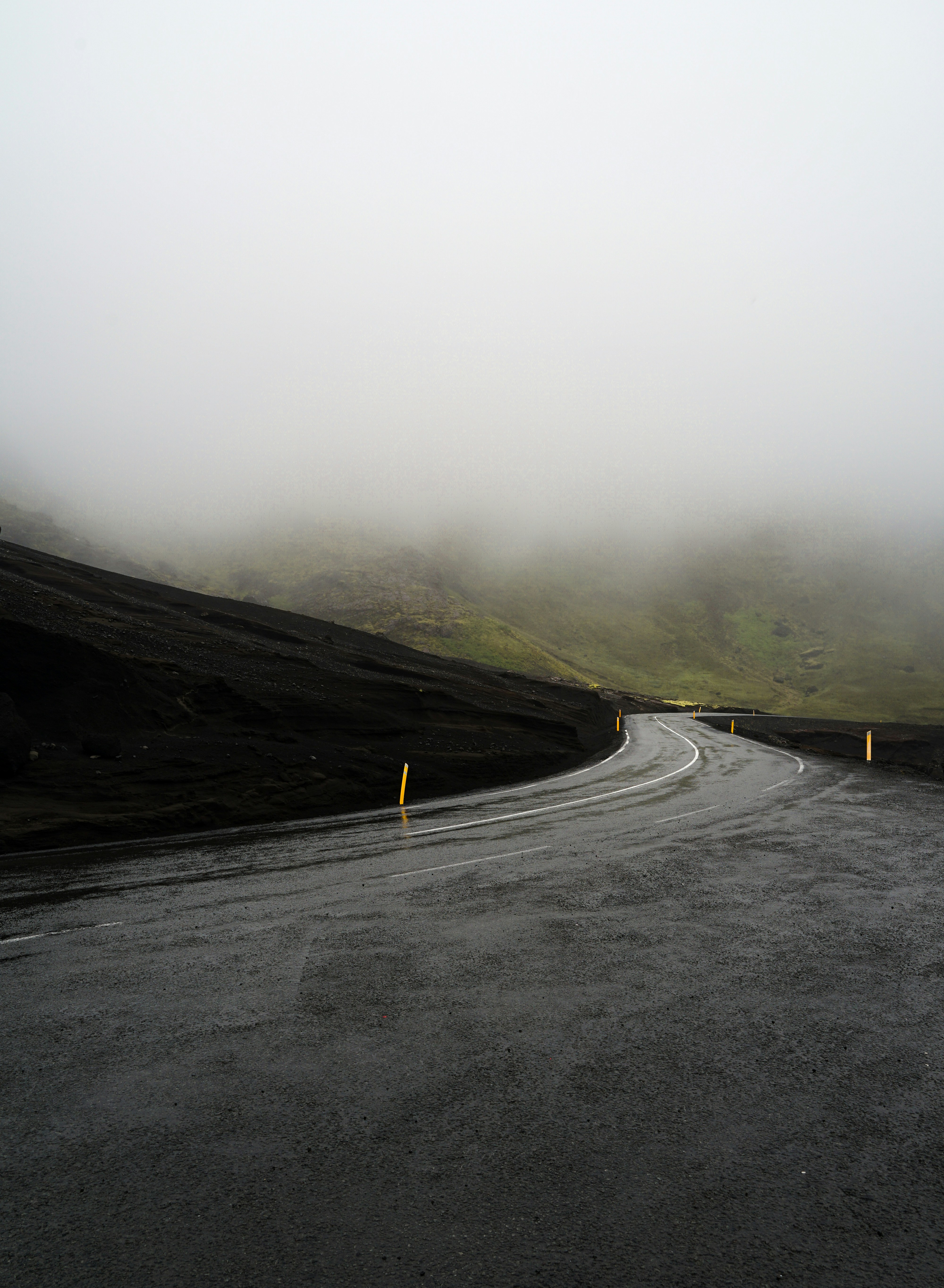 Fog-Wrapped Bend Across a Lava-Black Moor