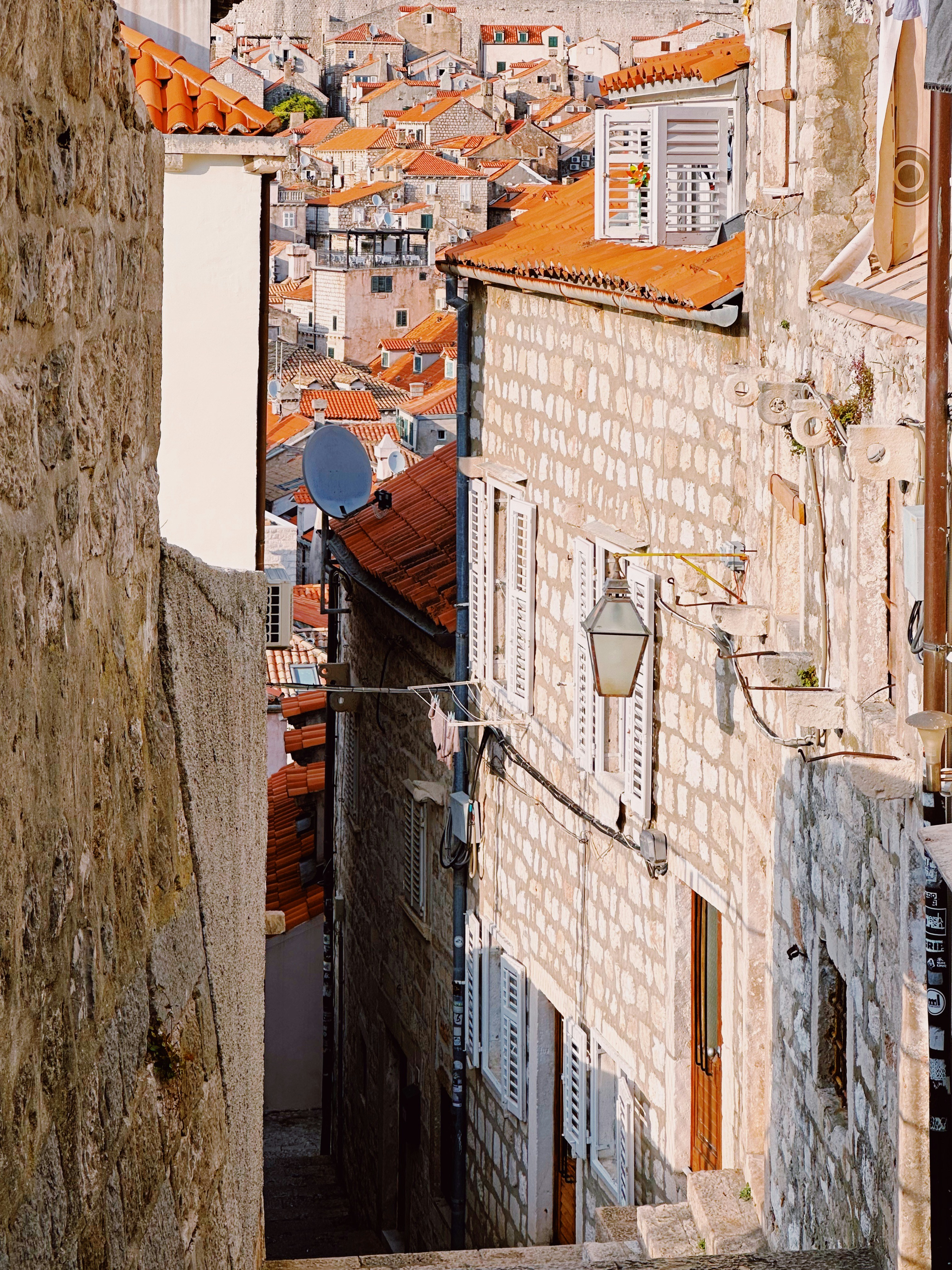 Terracotta Tunnels: A Sunlit Alley Between Stone Facades