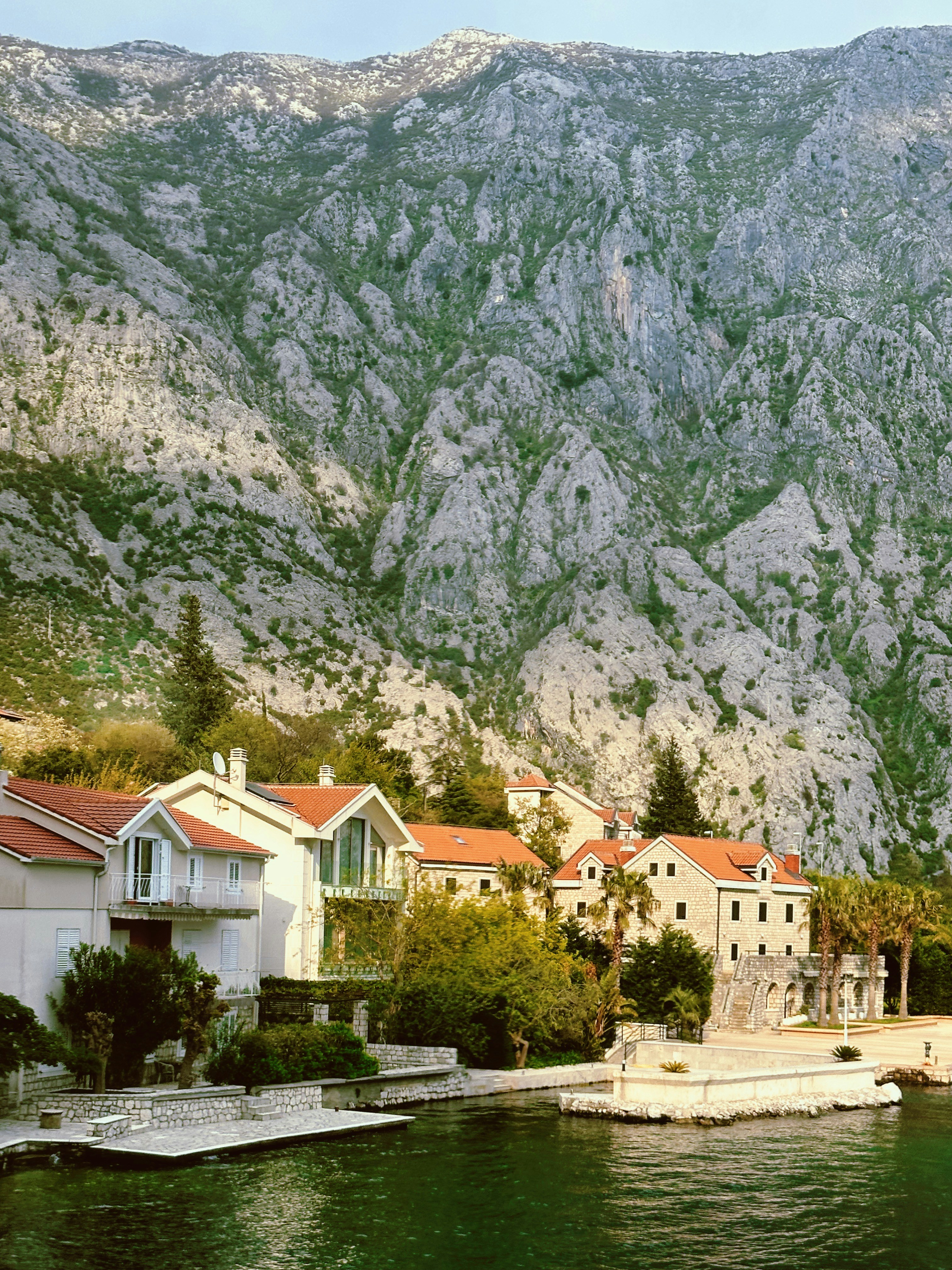 Harborfront Village Carved Against a Karst Mountain