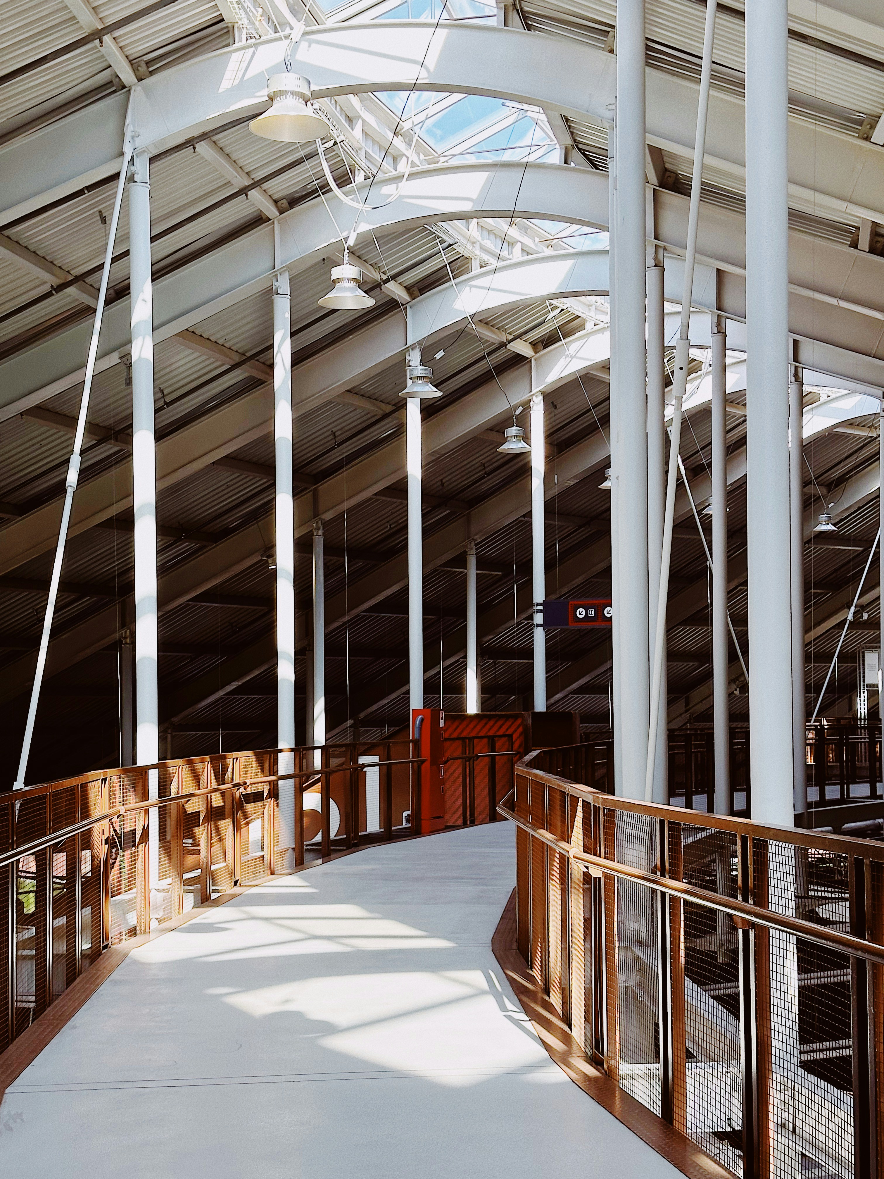 A walkway inside of a building with metal railings photo – Free Russian ...