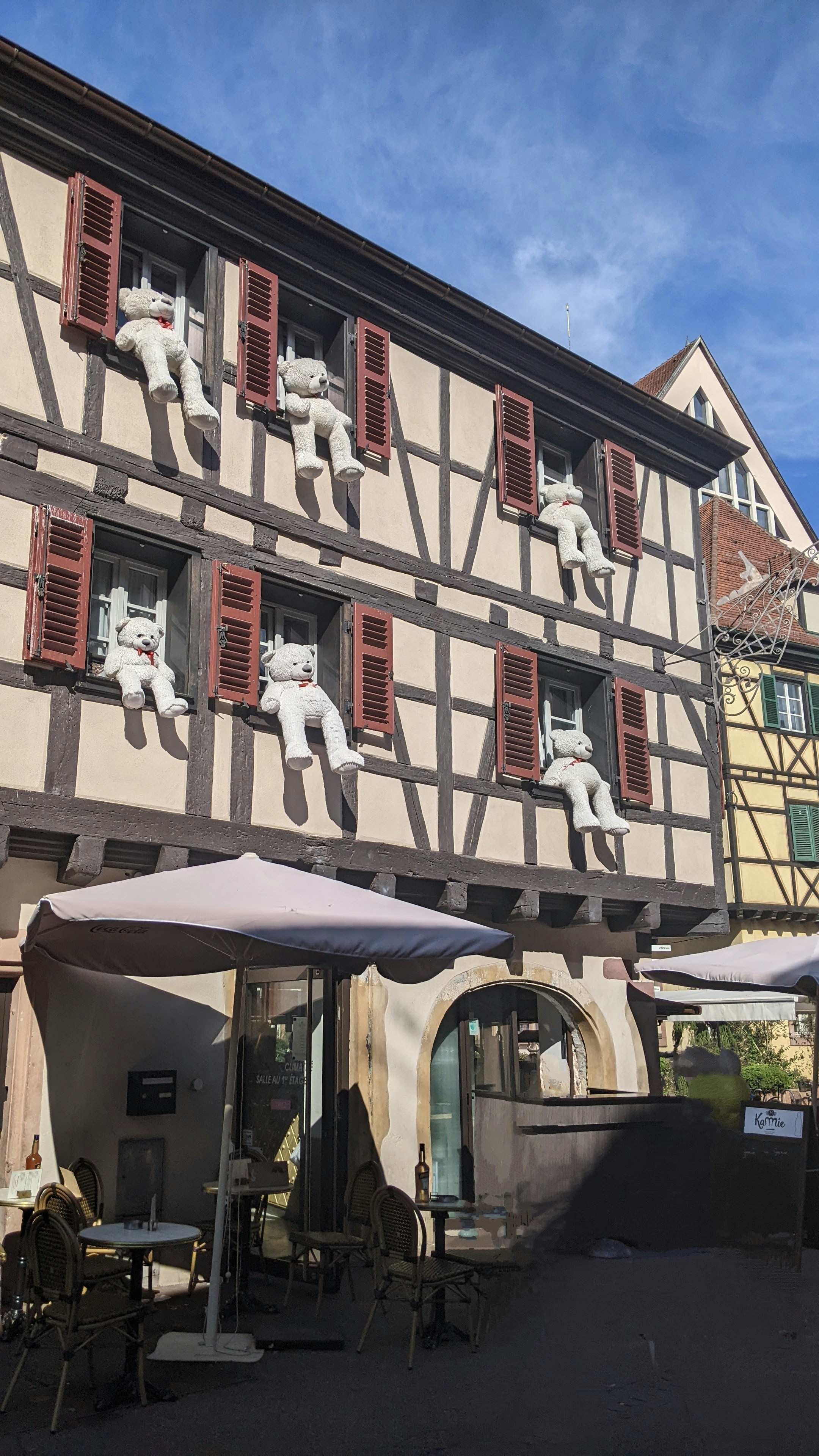 Row of Window-Watching Teddy Bears on a Half-Timbered Façade