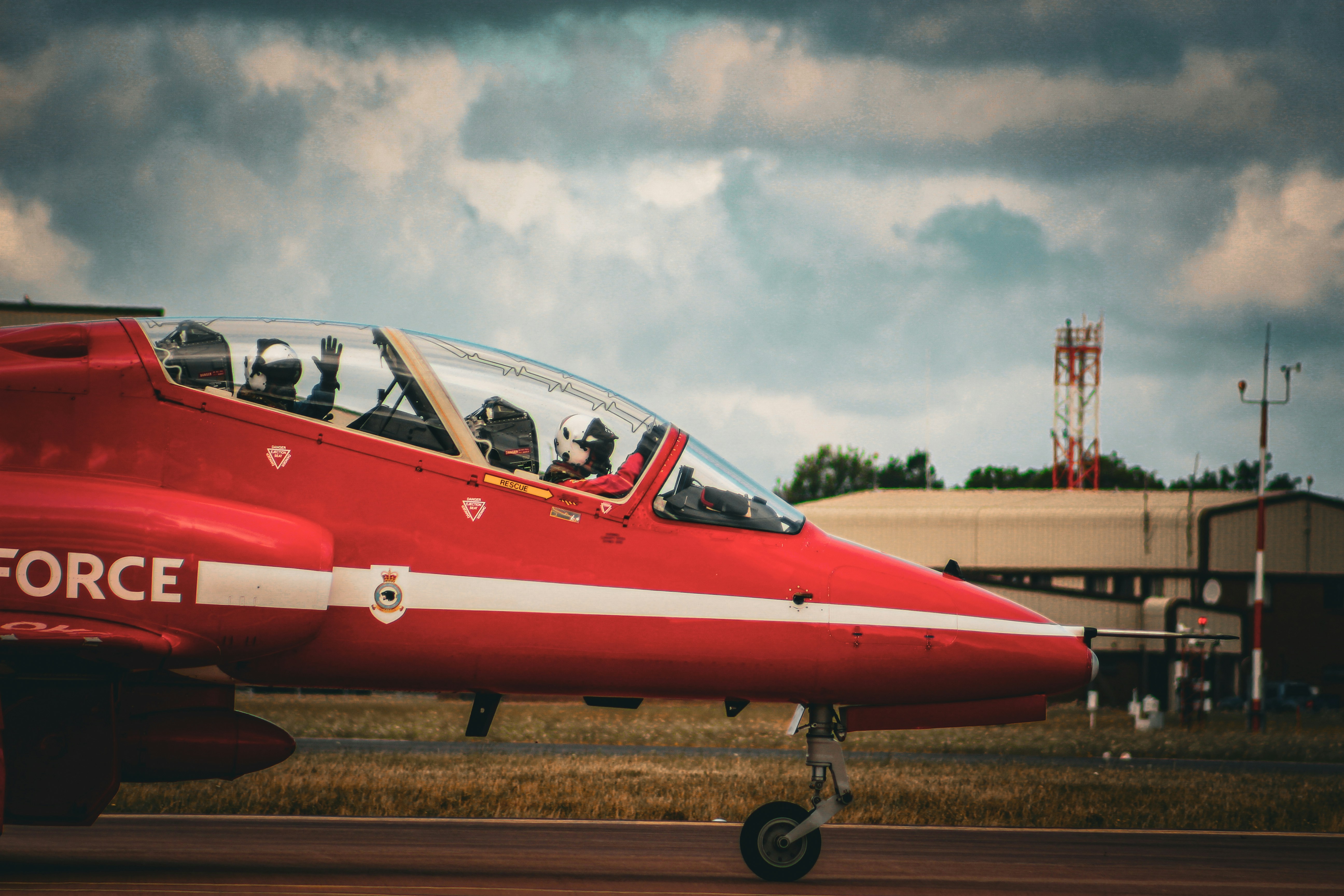 A red fighter jet sitting on top of an airport tarmac photo – Free ...