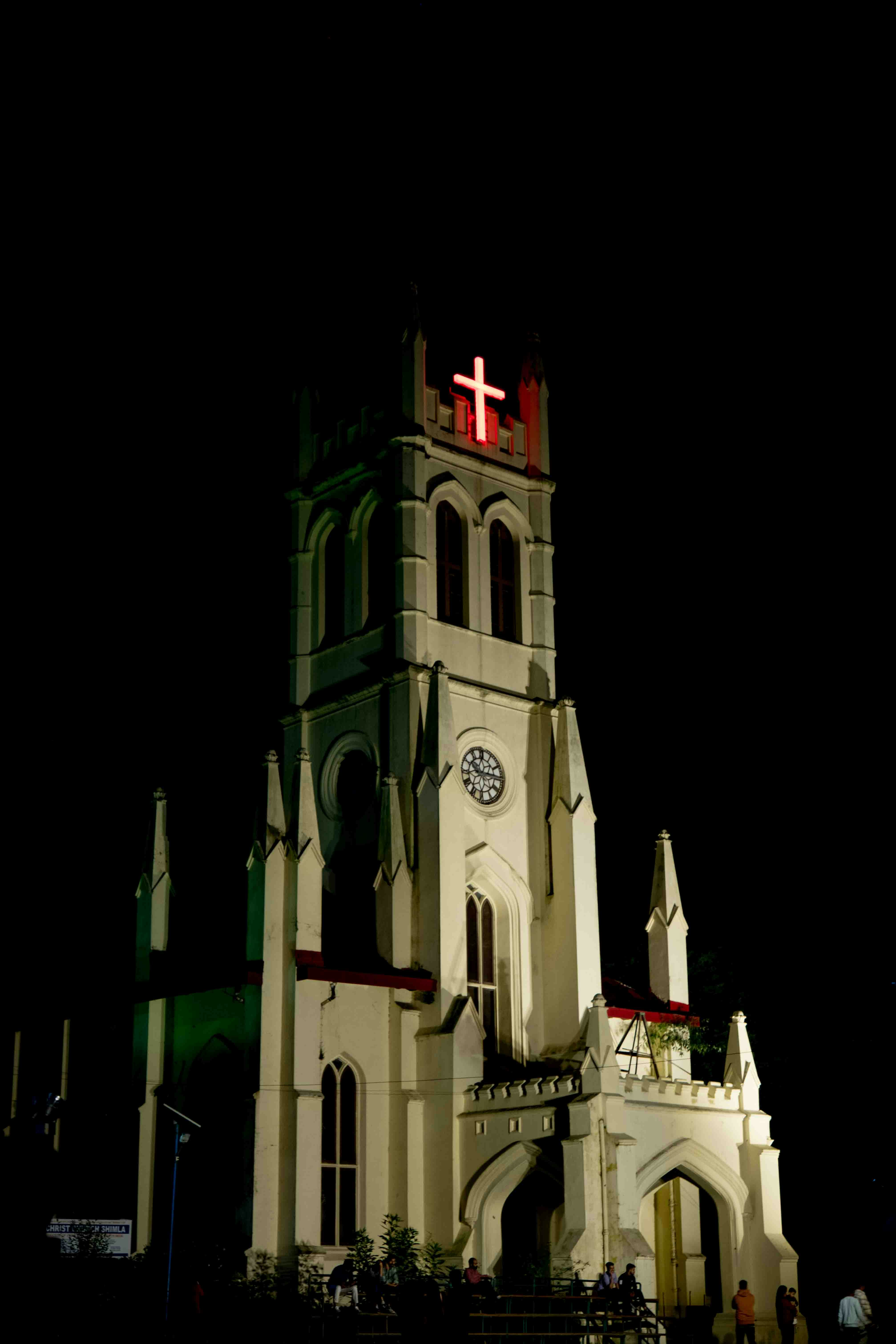 Crimson Cross Over Night: Illumination on a Gothic Church Tower