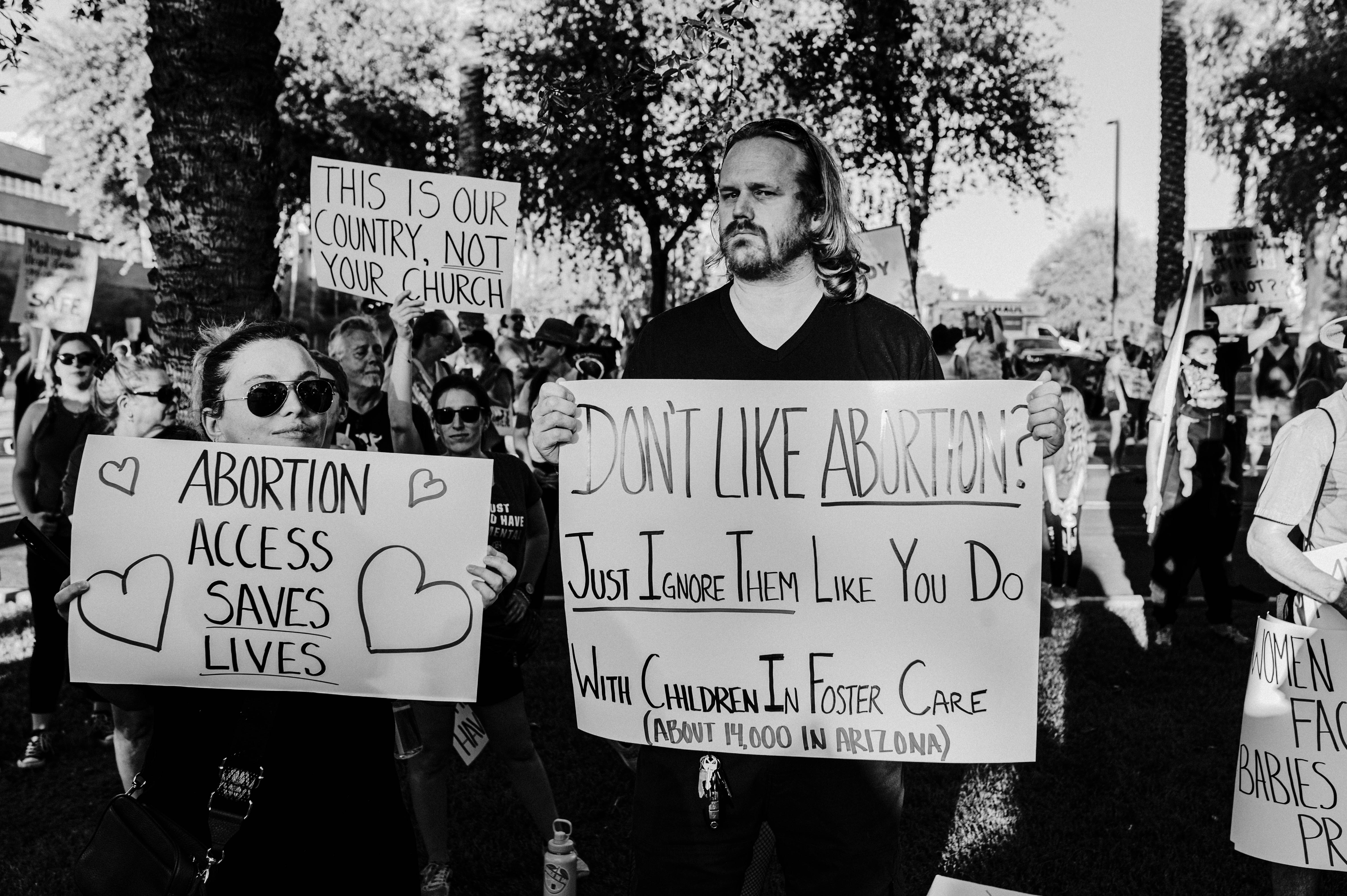 A group of people holding signs in a protest photo – Free Protest Image ...