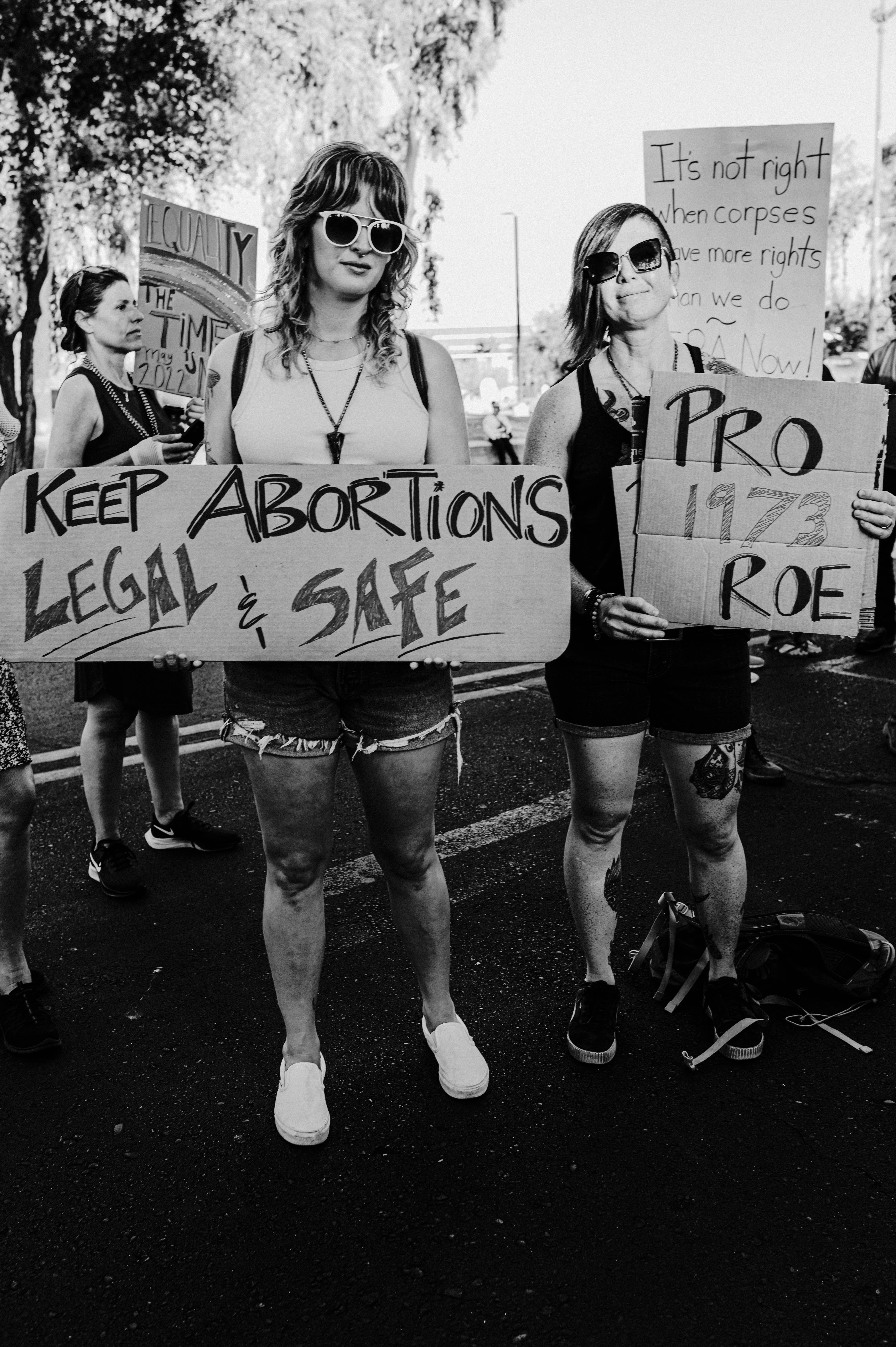 A group of people holding signs in the street photo – Free Portrait ...