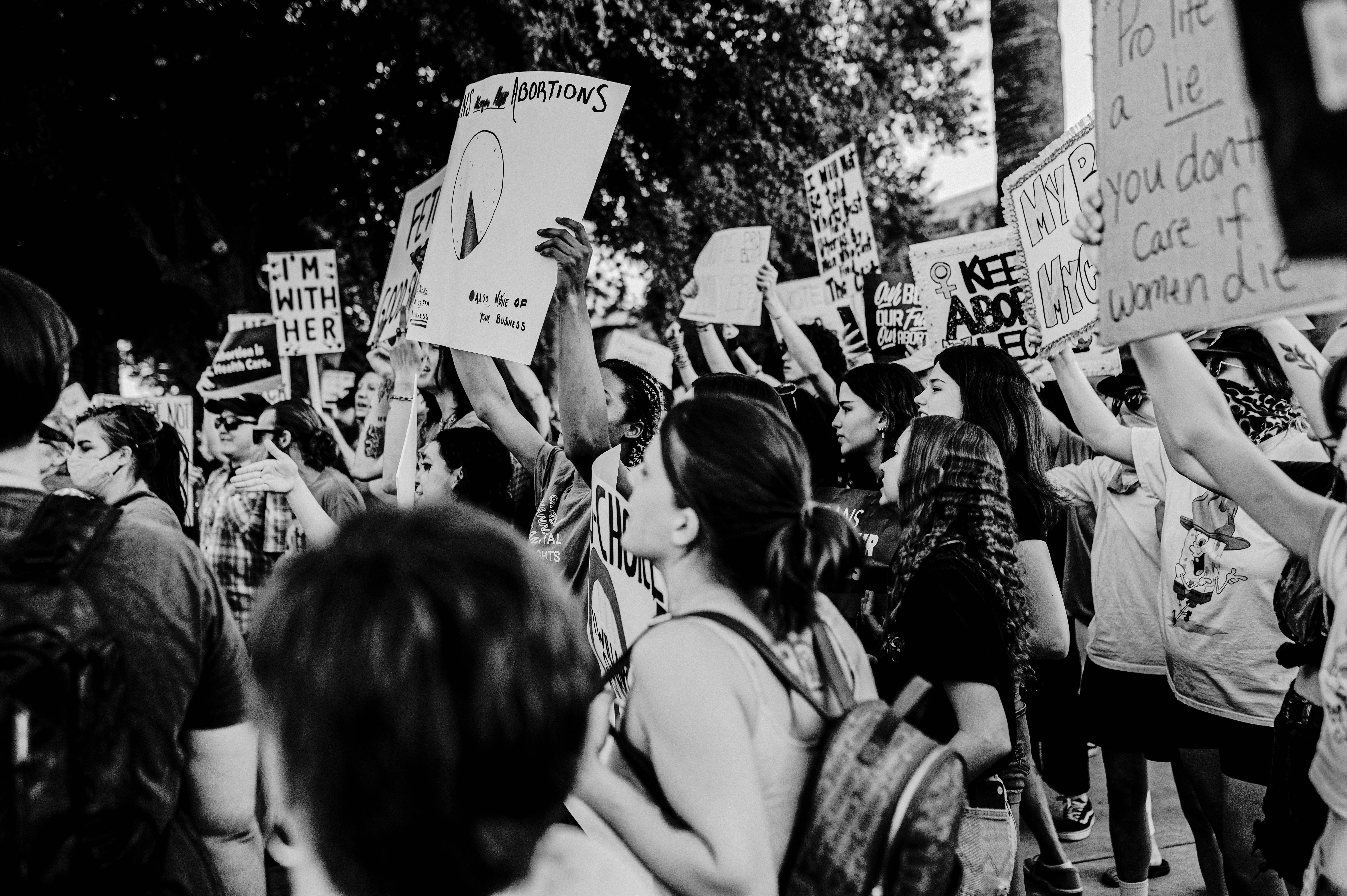 A large group of people holding up signs photo – Free Image on Unsplash