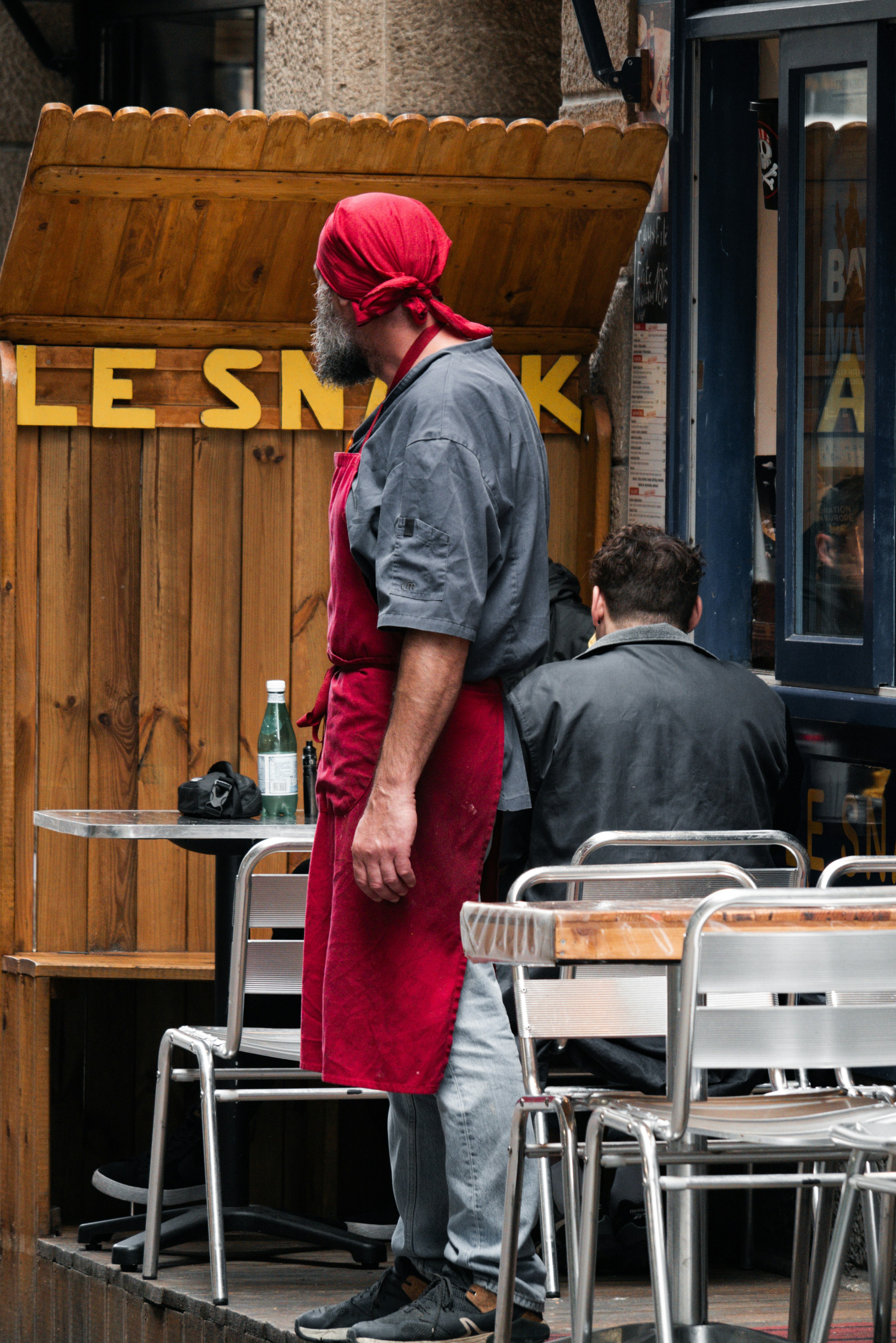 Red-turbaned chef in an urban courtyard café