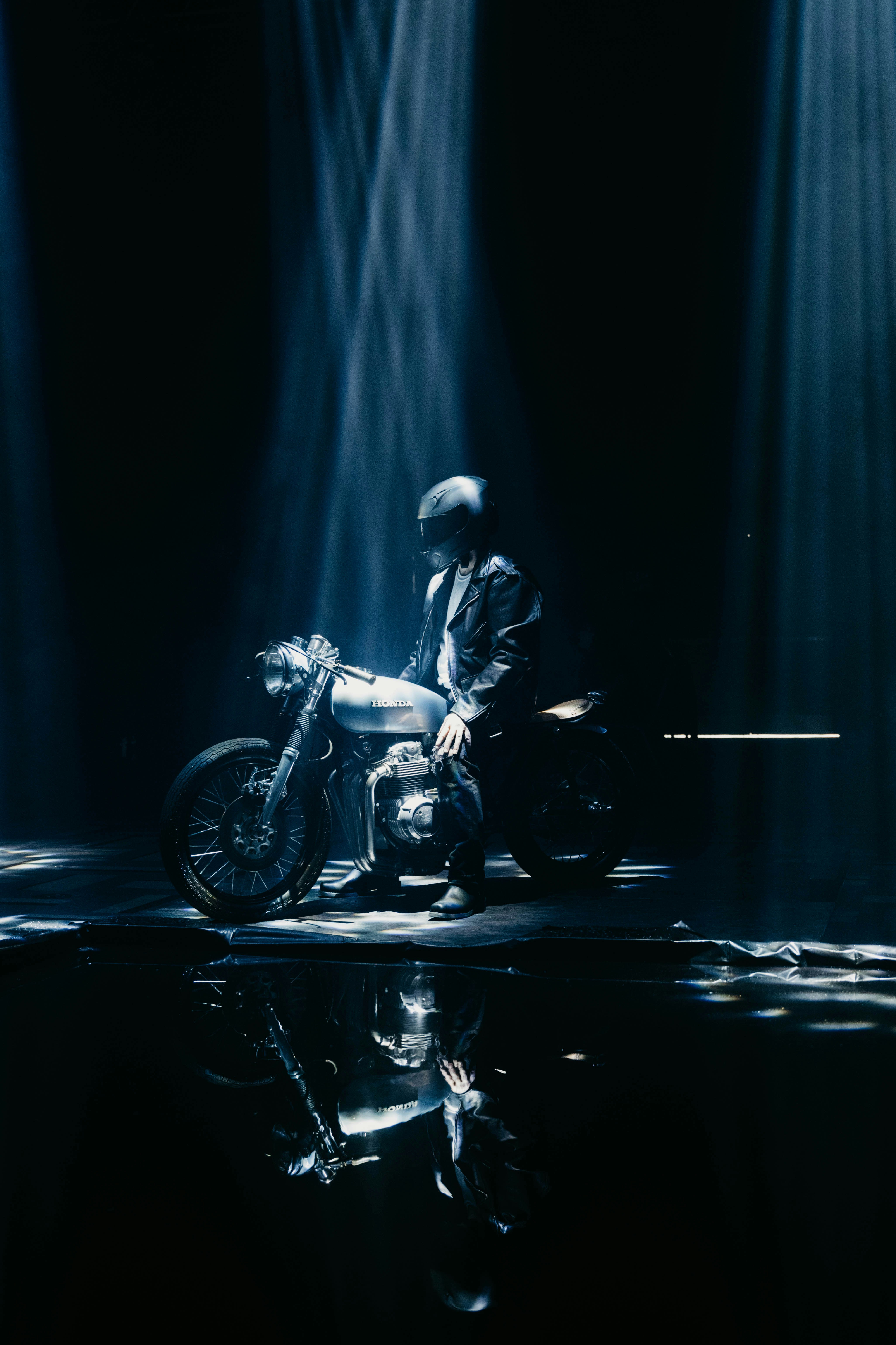A man sitting on a motorcycle in the dark photo – Free Motorcycle Image ...