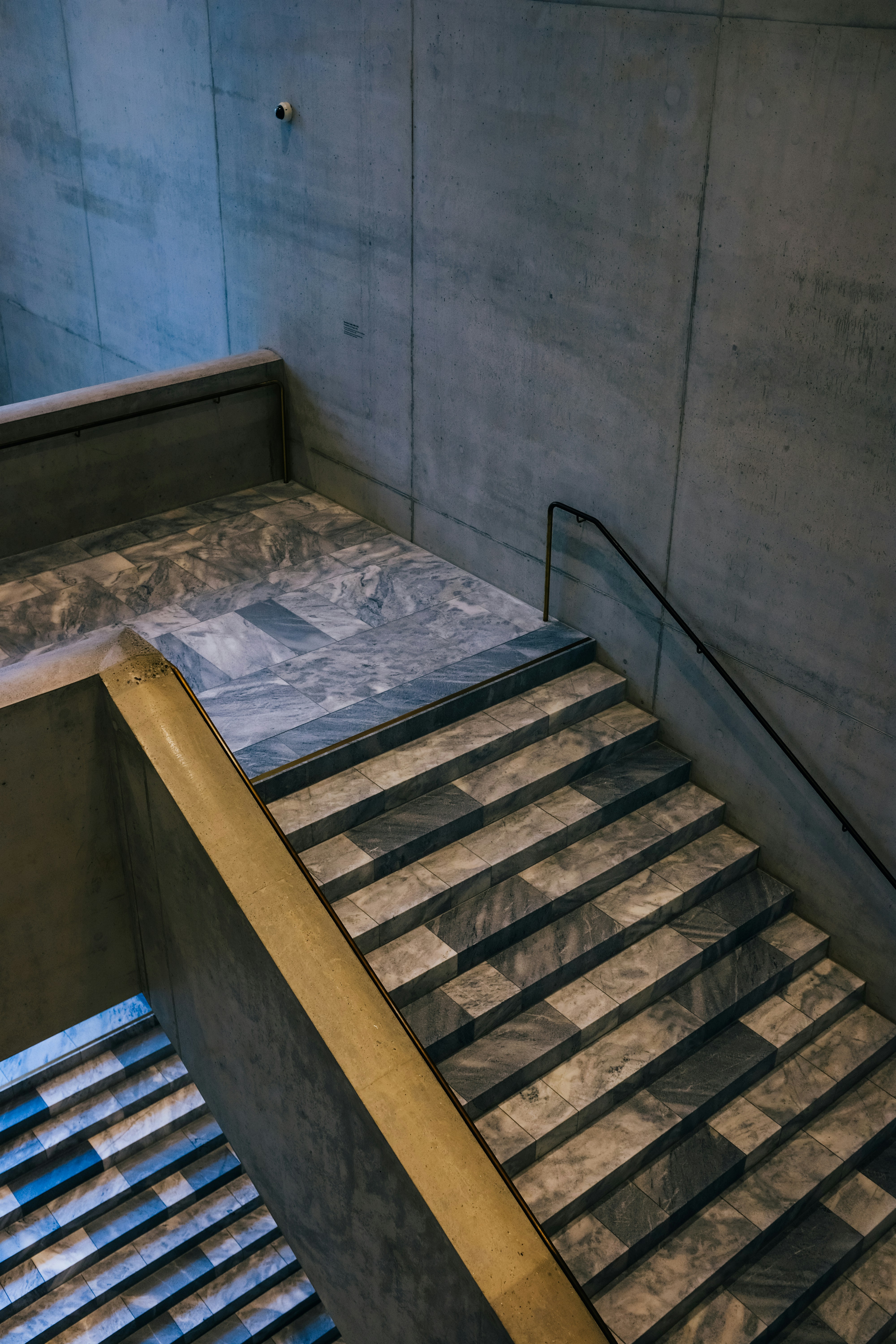 Descent Through Blue-Gray Geometry: Marble Steps in a Concrete Stairwell