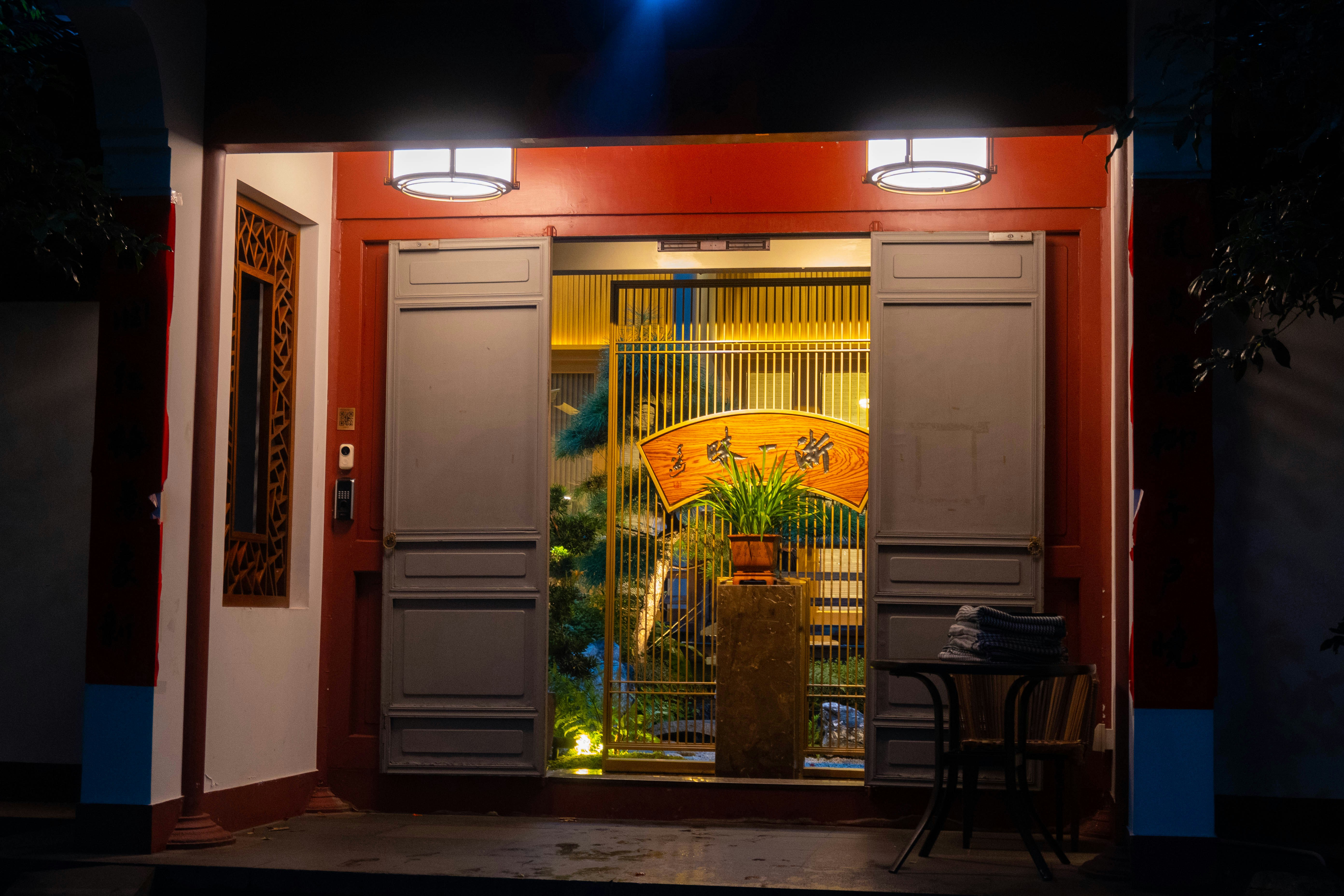 Open Threshold: Lantern-Lit Interior Framed by Shadows
