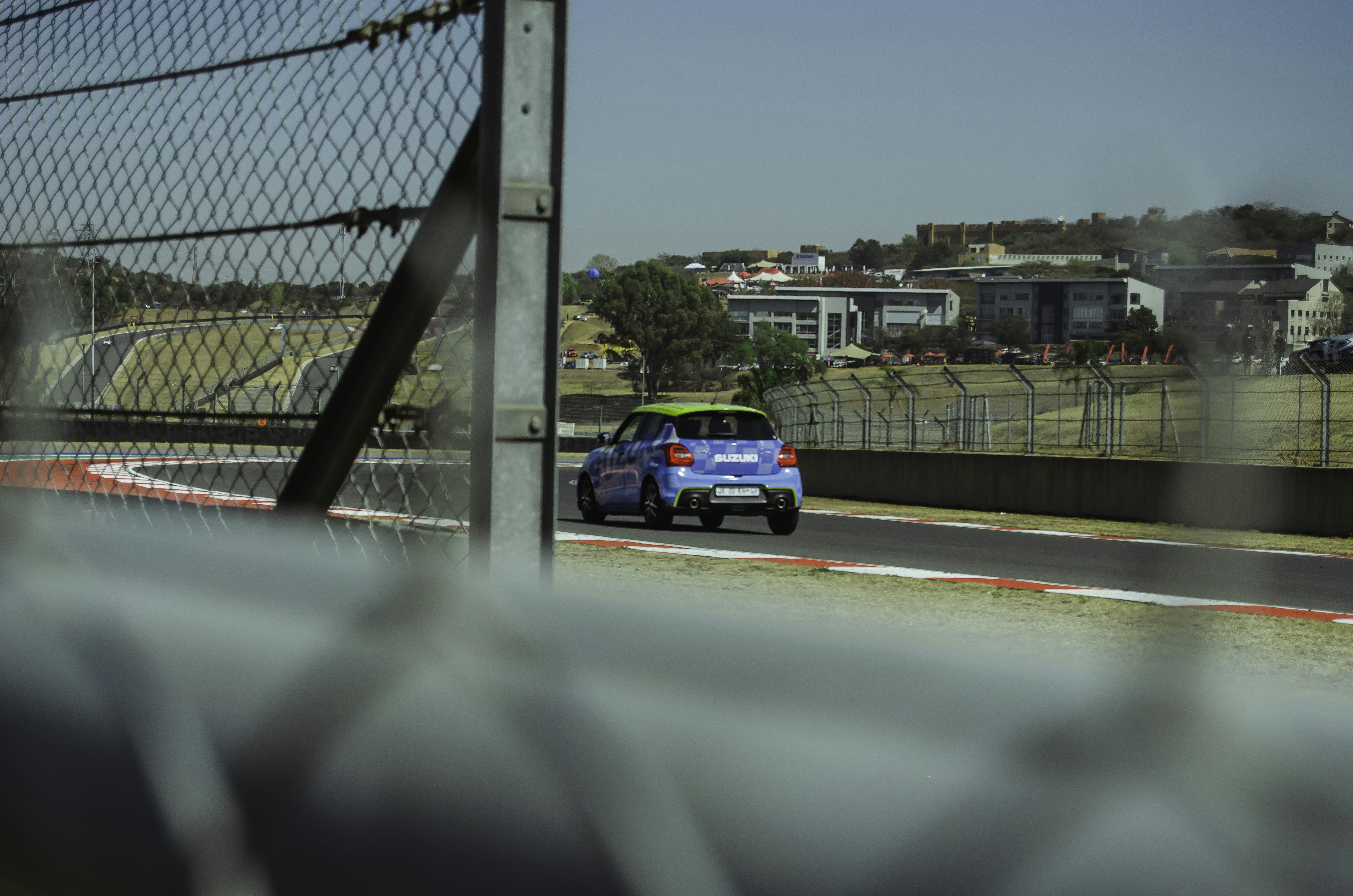 A blue car driving down a race track photo – Free Kyalami grand prix ...