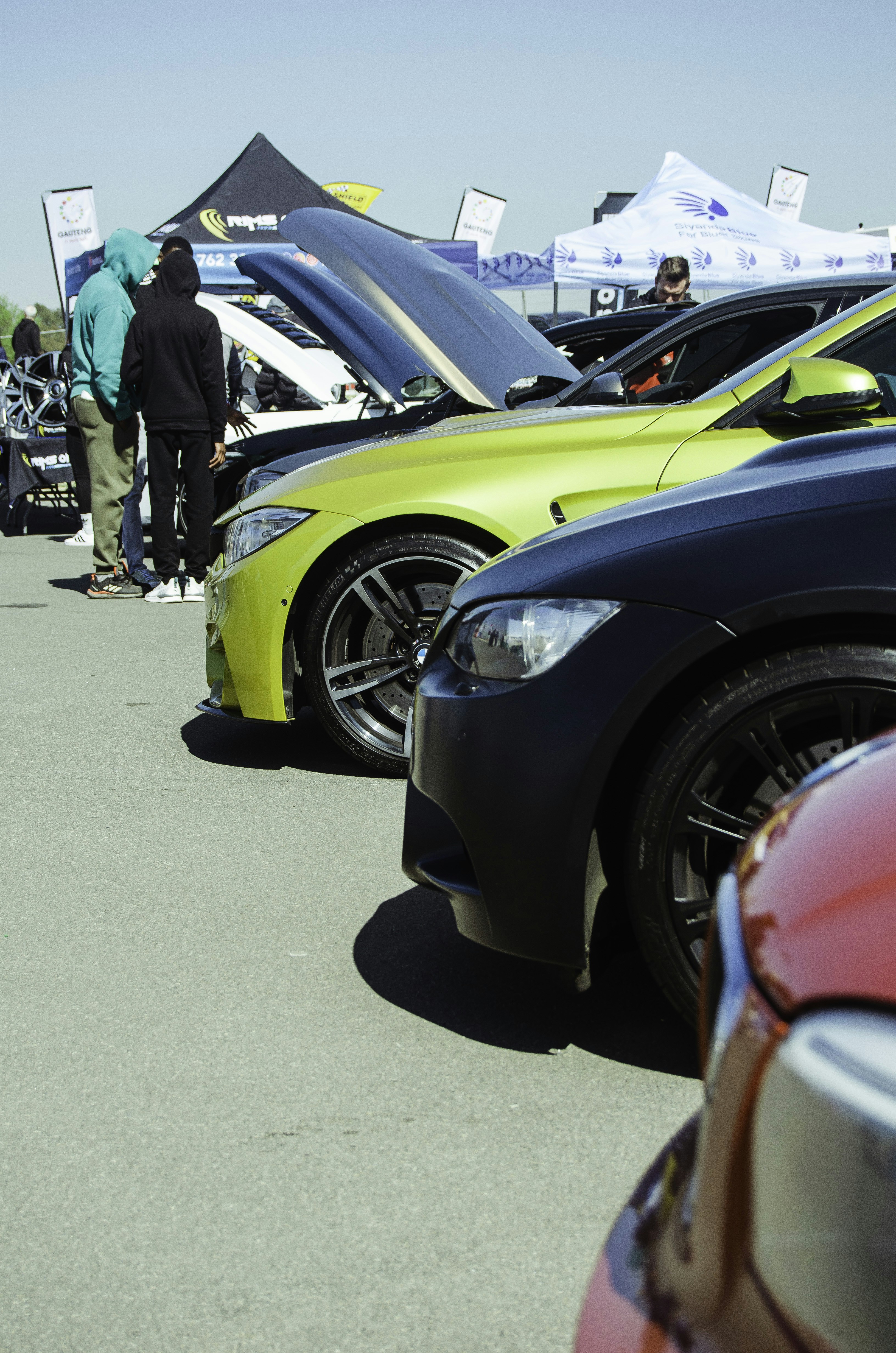 Amber Cerulean Row: A Lineup of Vibrant Exotics at the Car Show